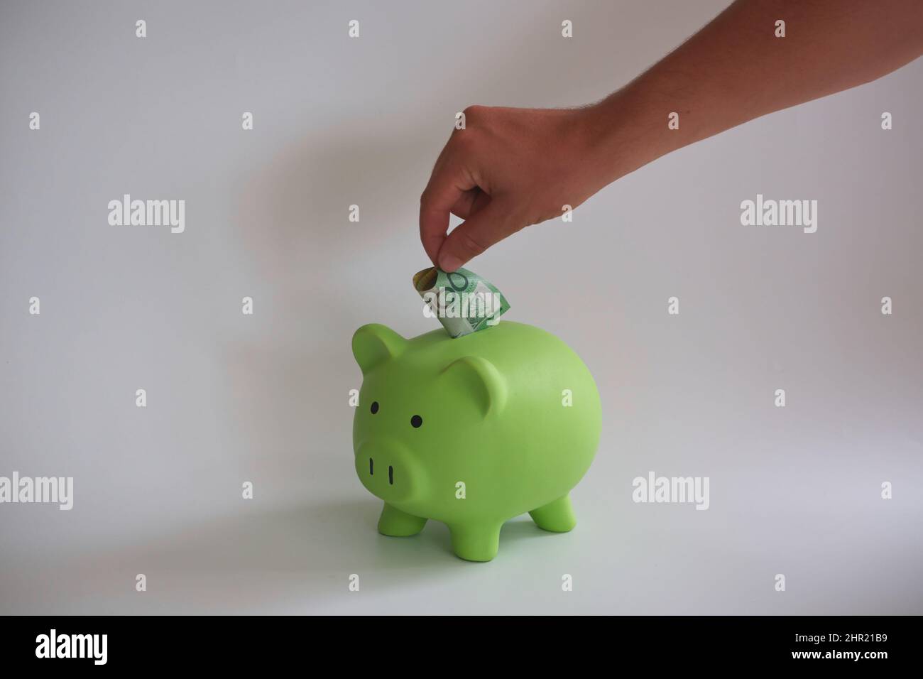 Piggy Bank with $100 Australian dollar banknote Stock Photo - Alamy