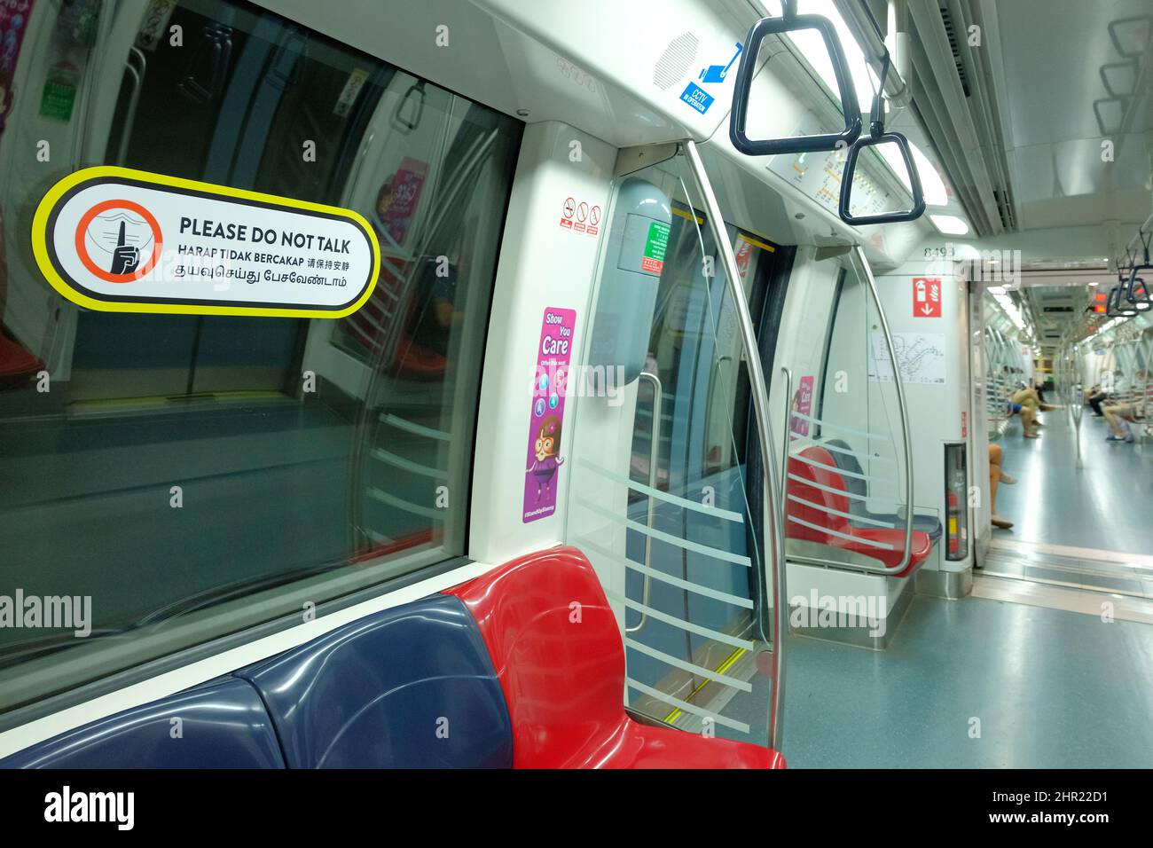 Decal of masked person with index finger over mouth in subway train ...