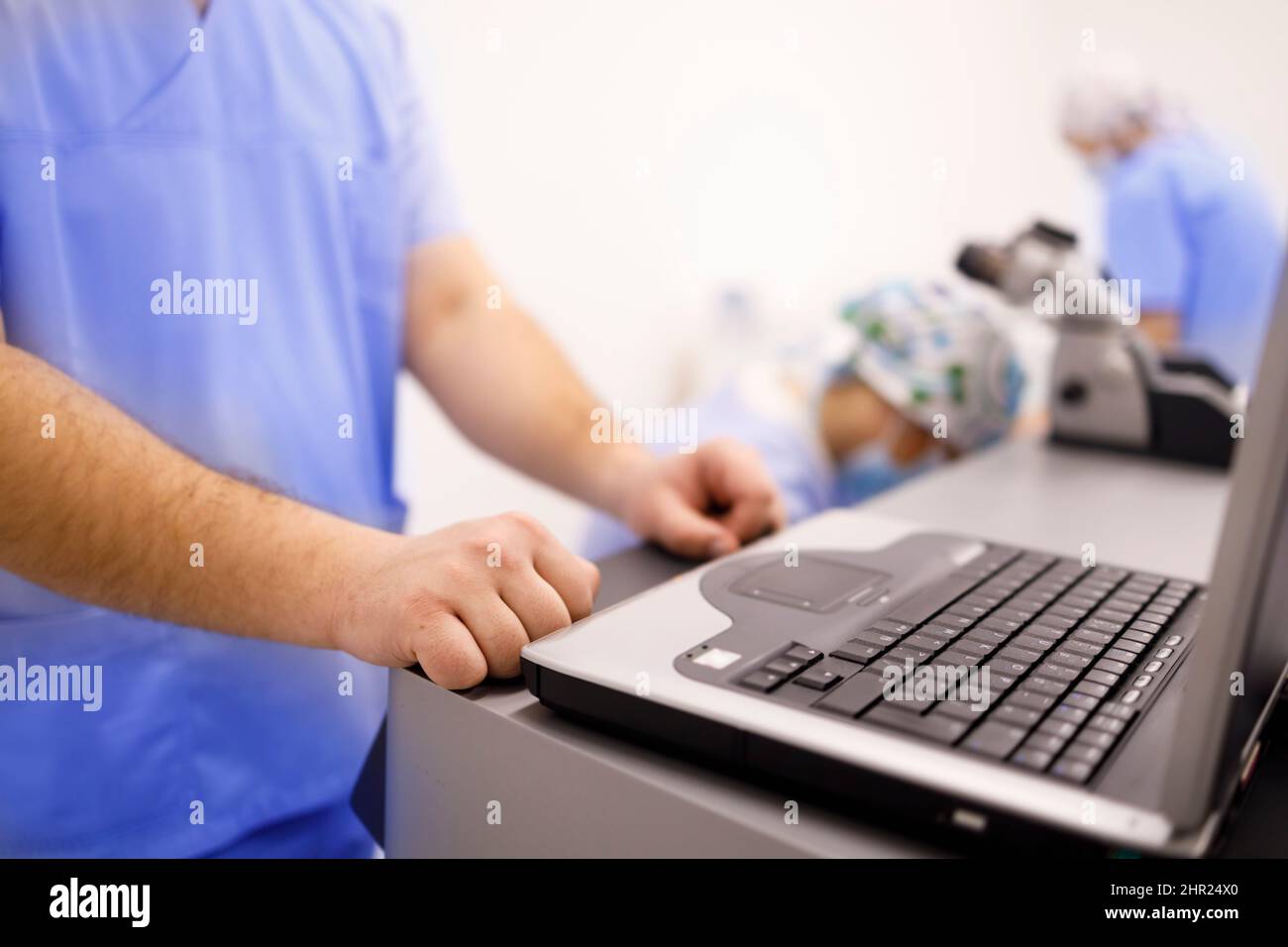 A doctor using a computer during research in a health clinic Stock ...