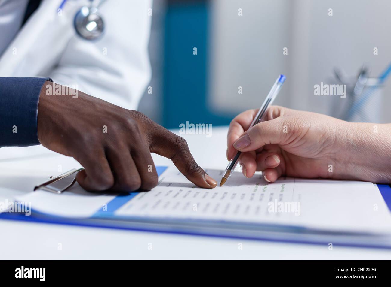 Close up of woman hand signing healthcare coverage policy and ...