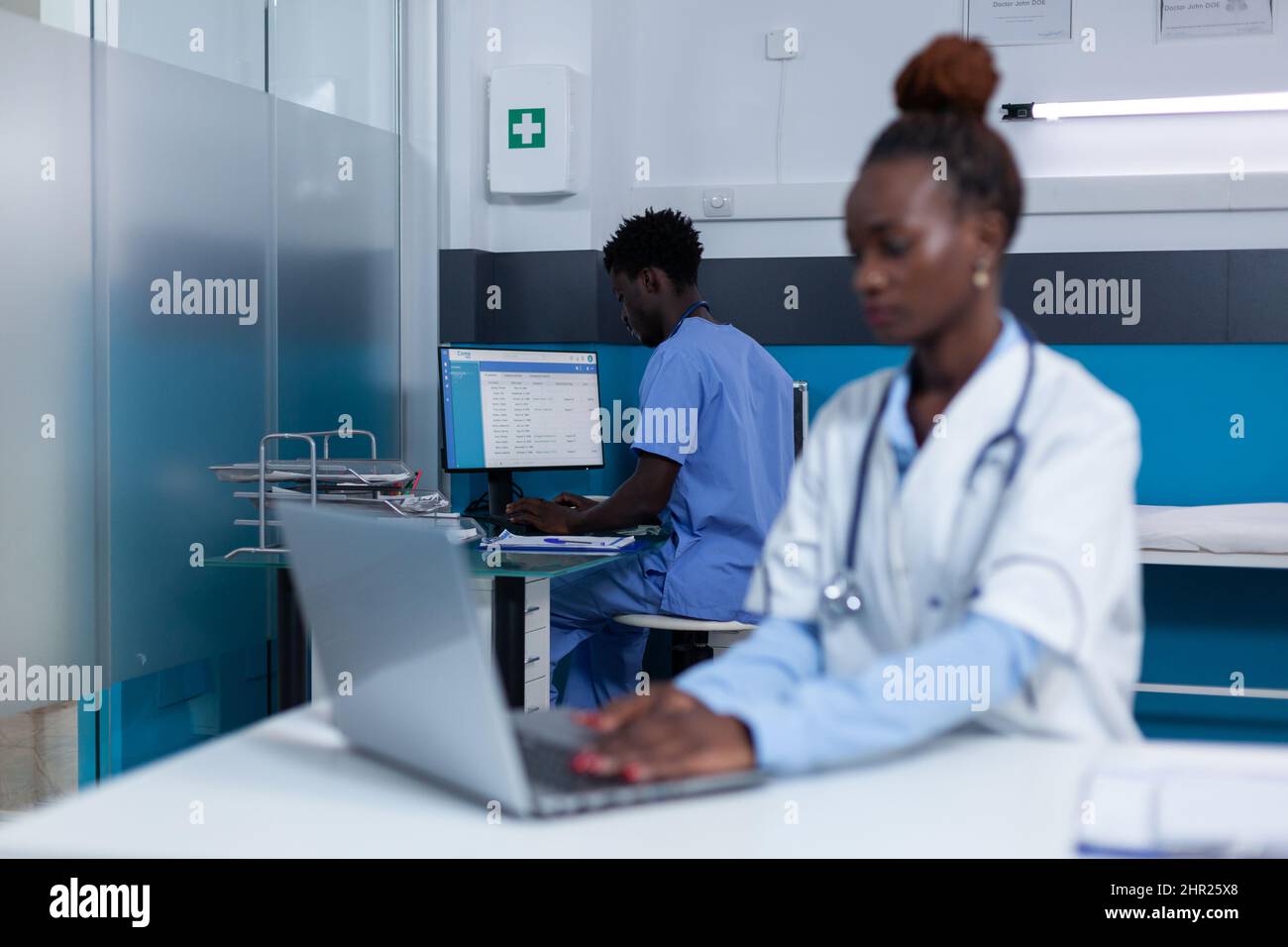 Hospital nurse verifying patient medical records and updating treatment ...