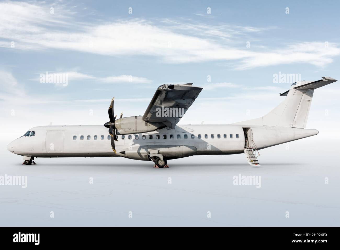 White passenger turboprop aircraft with an open staircase ladder ...