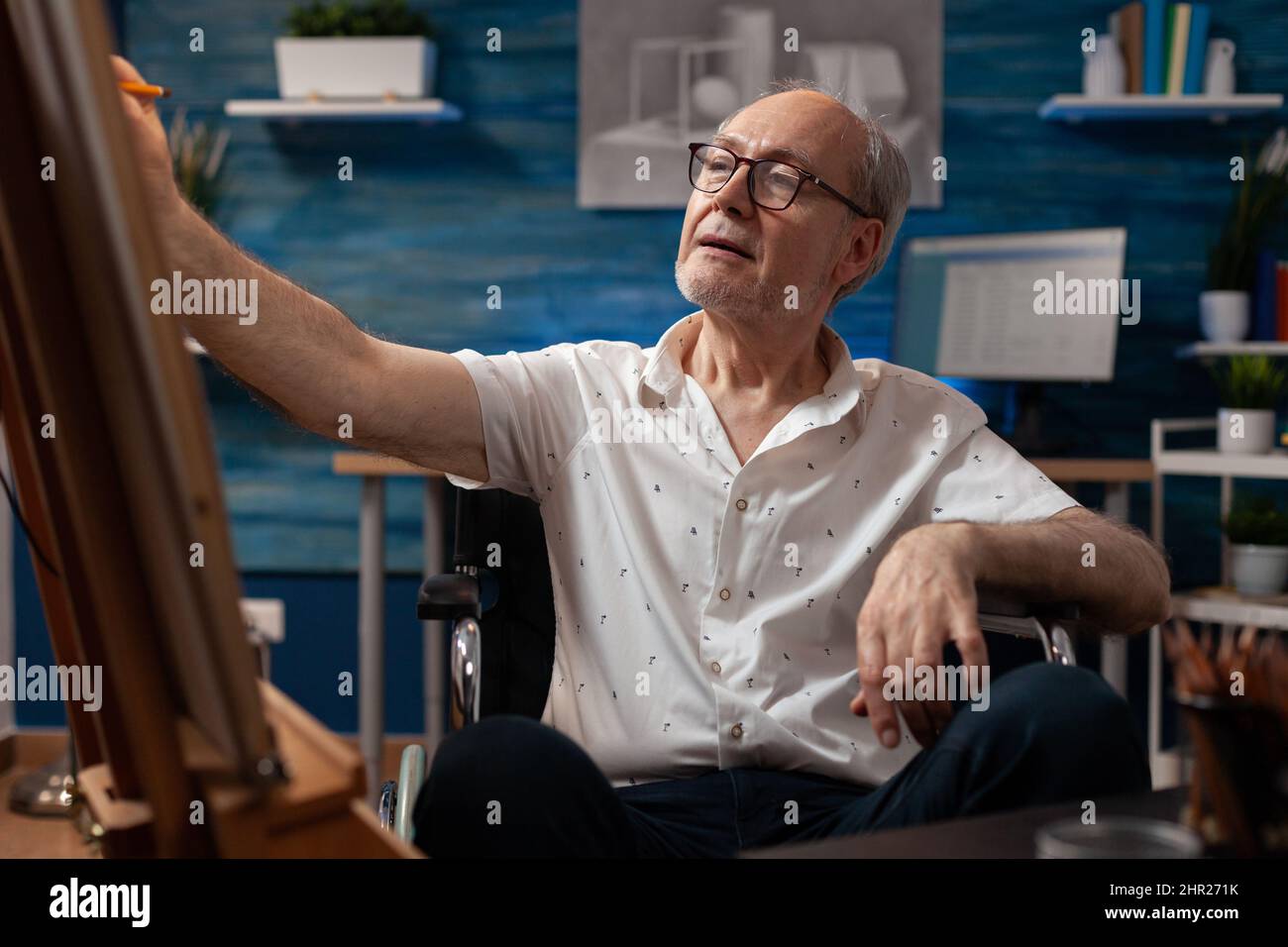 Elderly man artist sitting in wheelchair drawing black and white sketch ...