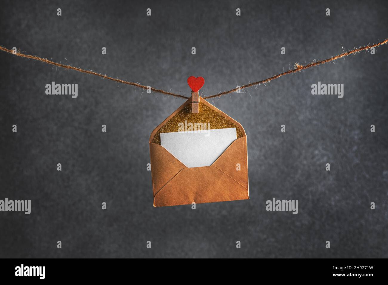 an envelope with a message hanging on a rope Stock Photo - Alamy