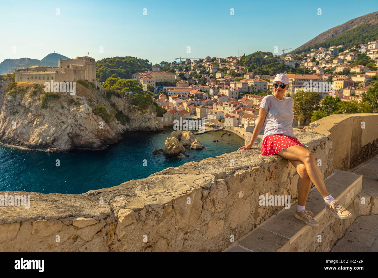 girl resting on top walls of Dubrovnik city of Croatia. Looking Fort ...