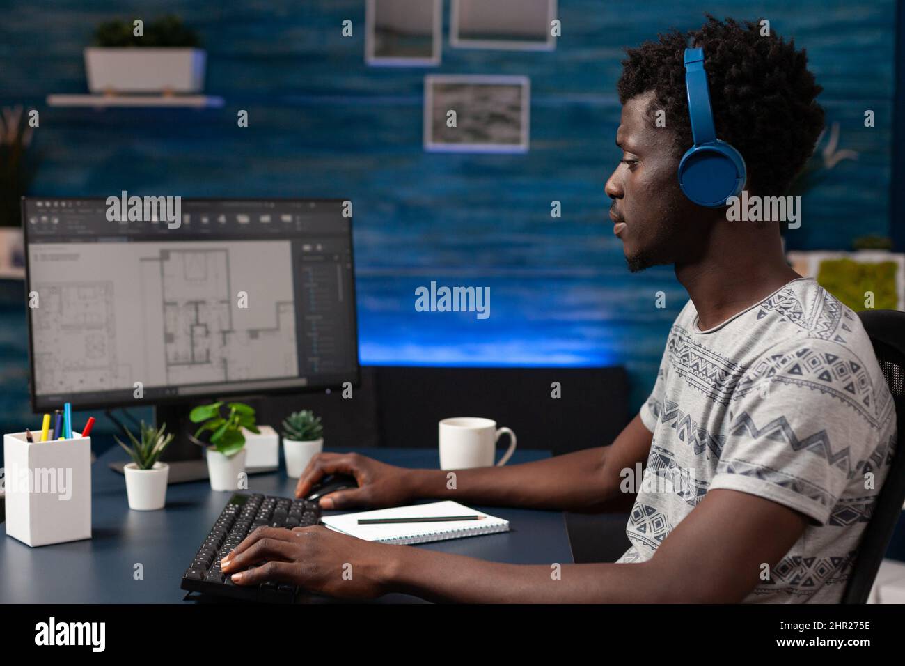 Professional technician designer sitting at desk analyzing contemporary ...