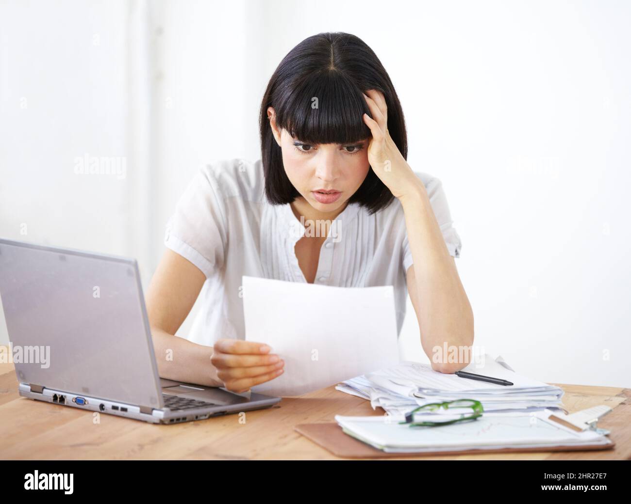 Ive gone way over budget. A shocked businesswoman reading the financial ...