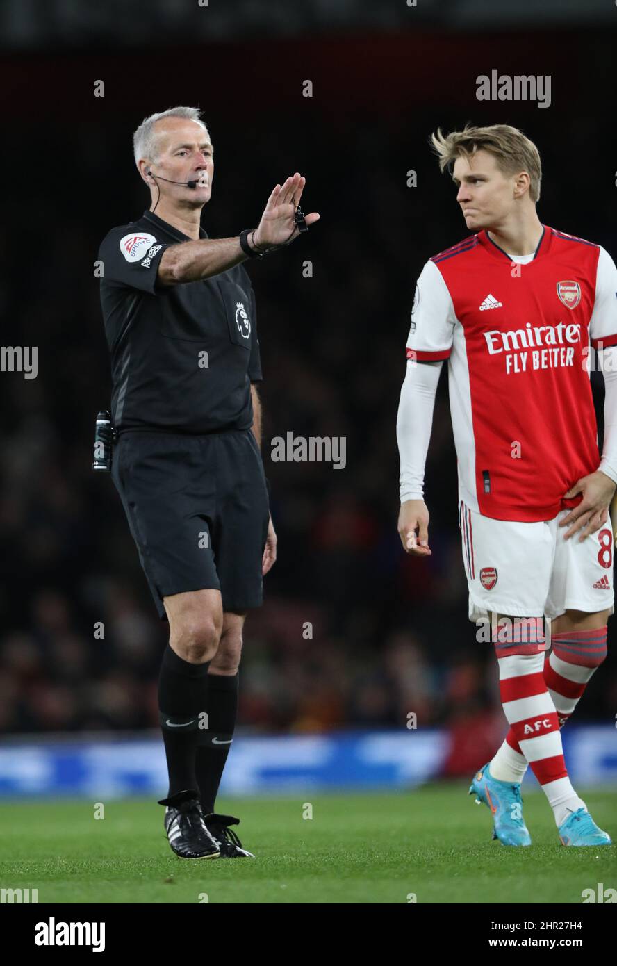 London, UK. 24th Feb, 2022. Referee Martin Atkinson and Martin Odegaard ...
