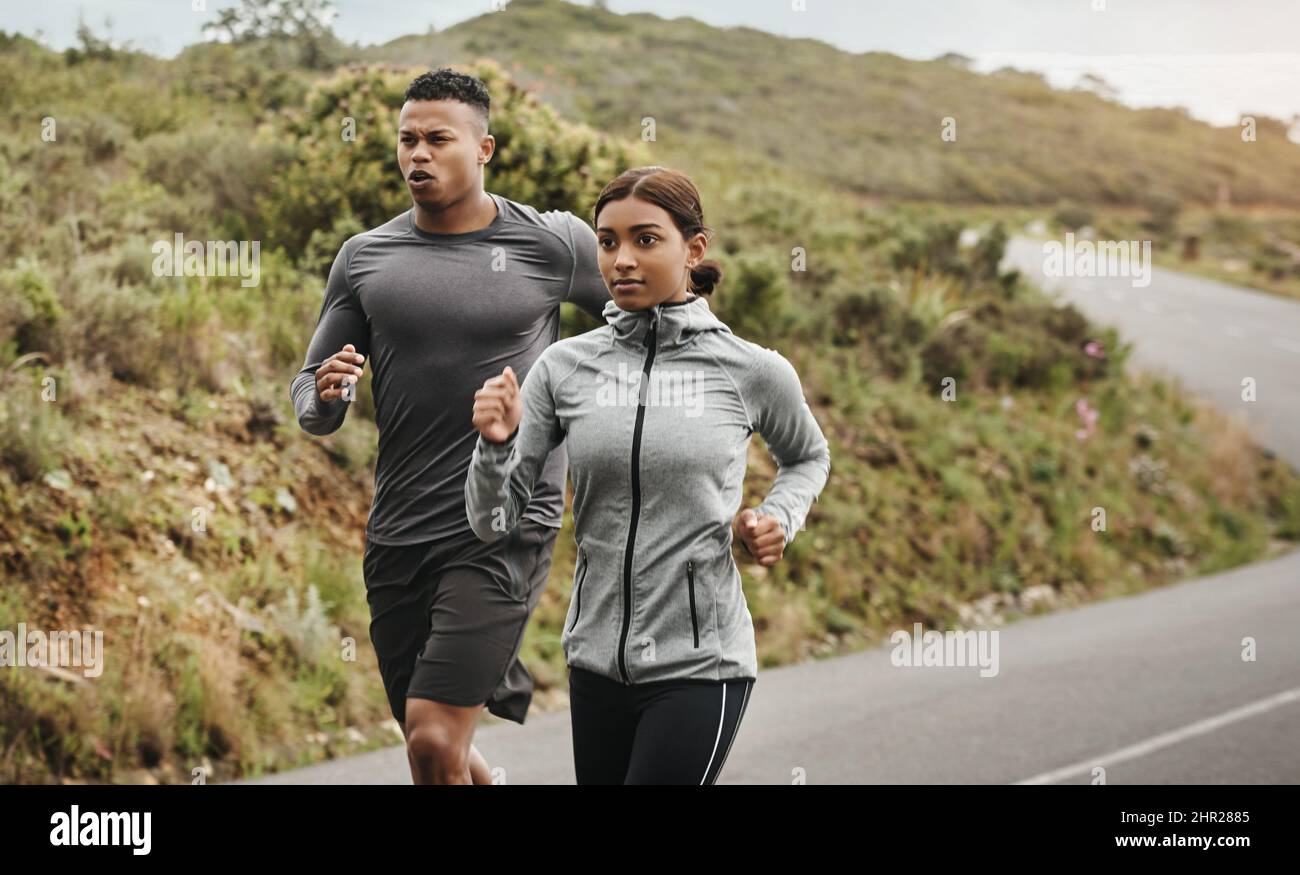 Dont stop until you reach the end. Shot of two sporty young people ...