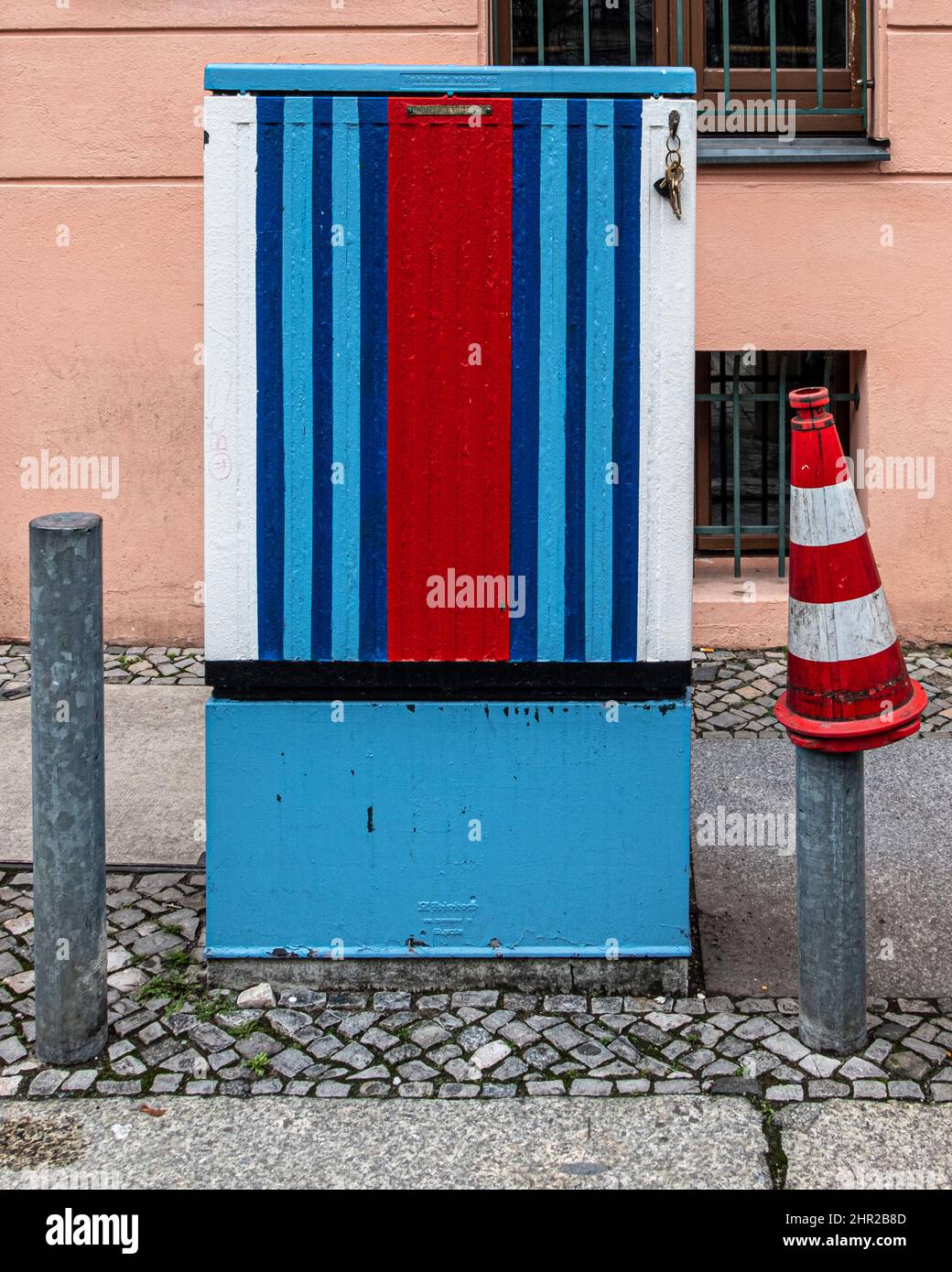 Red White and Blue. Colourful Utilty Box and traffic cone on cobbled ...