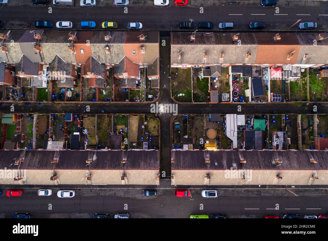 Aerial view of the rooftops of terraced houses and back gardens in a ...