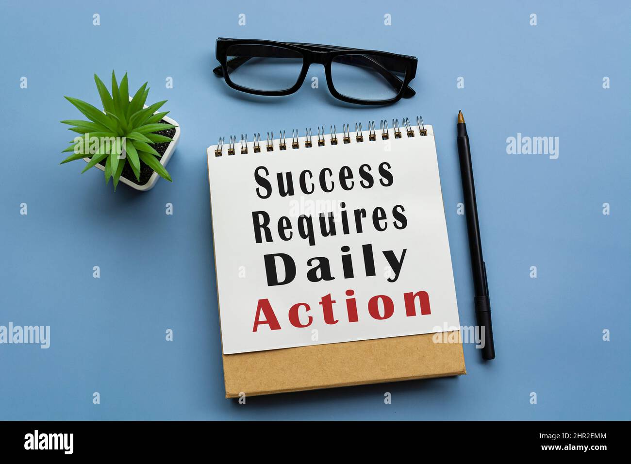 Motivational quote on notepad - Success requires daily action Stock ...