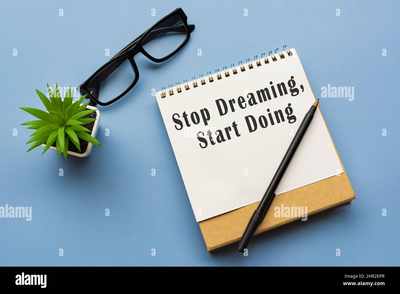 Motivational and inspirational quote on notepad with potted plant ...