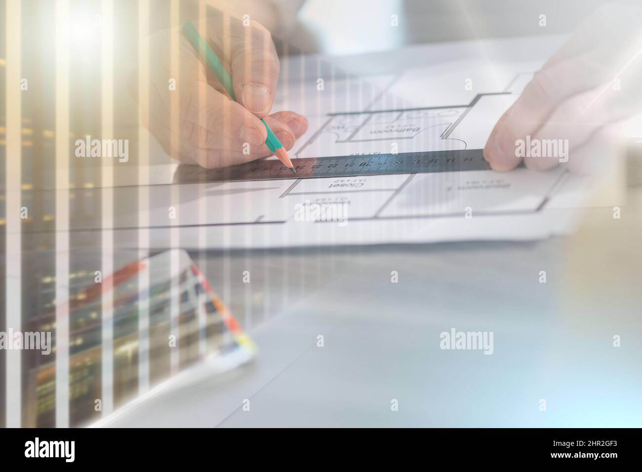 Architect working on a project and using a ruler; multiple exposure ...