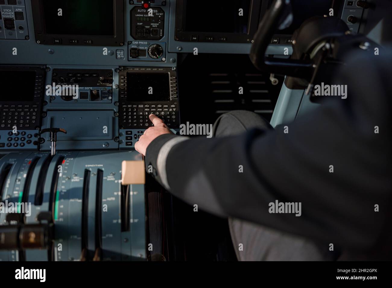 Airline pilot using instrument panel in aircraft cockpit Stock Photo ...