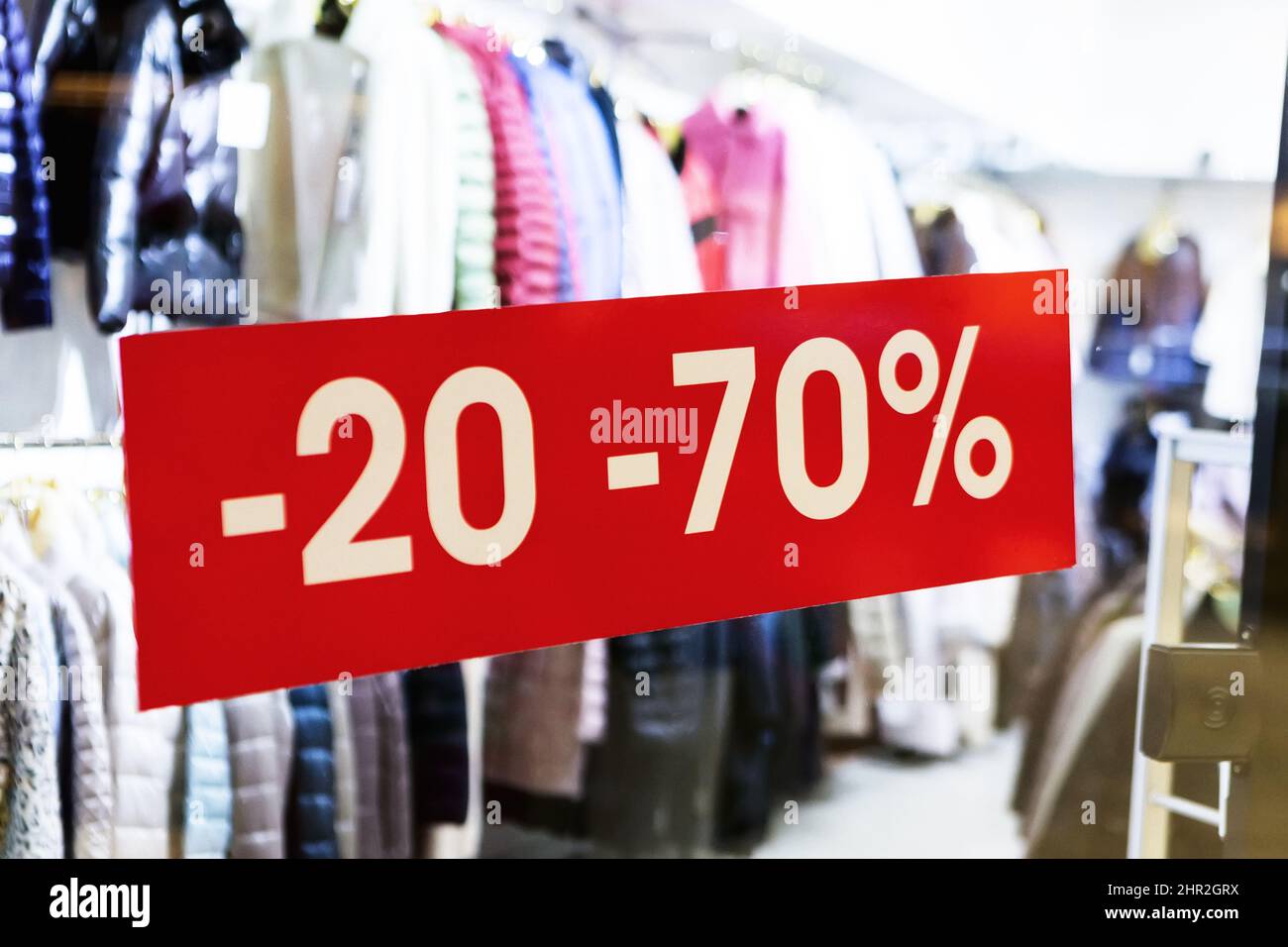 Shop window with text of sale on red poster. Clothes boutique ...