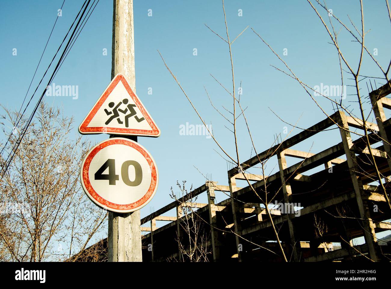 Speed limitation road sign with an unfinished building on background ...