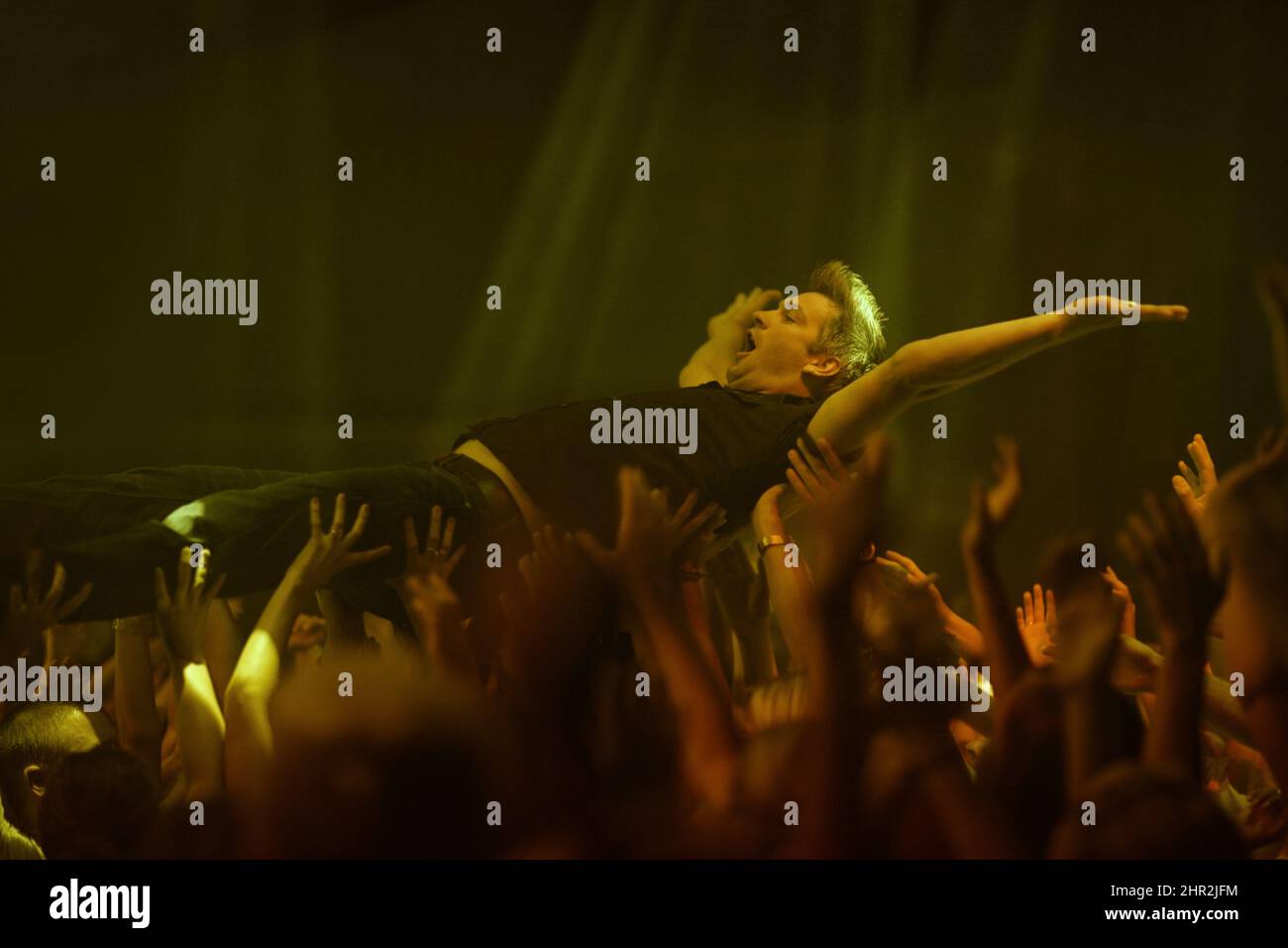 Surfing the crowd. A young woman crowd surfing at a concert Stock Photo ...