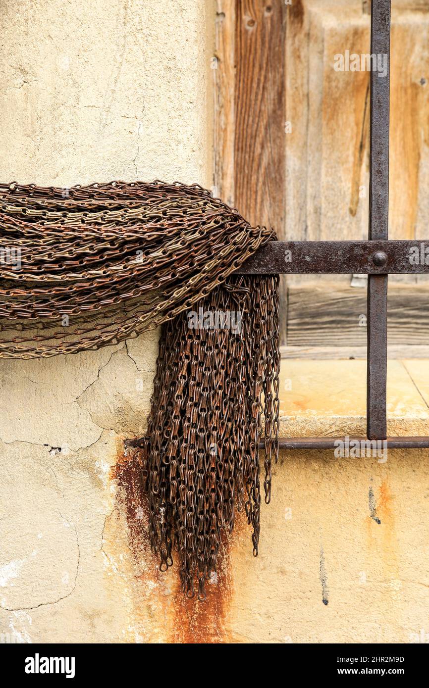 Broken and damaged window and metal chain curtain in an old house Stock ...