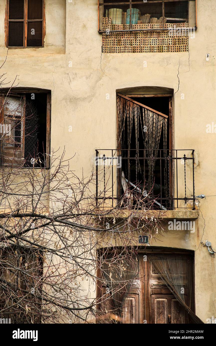 Broken and damaged windows and balcony in an old house facade in Spain ...