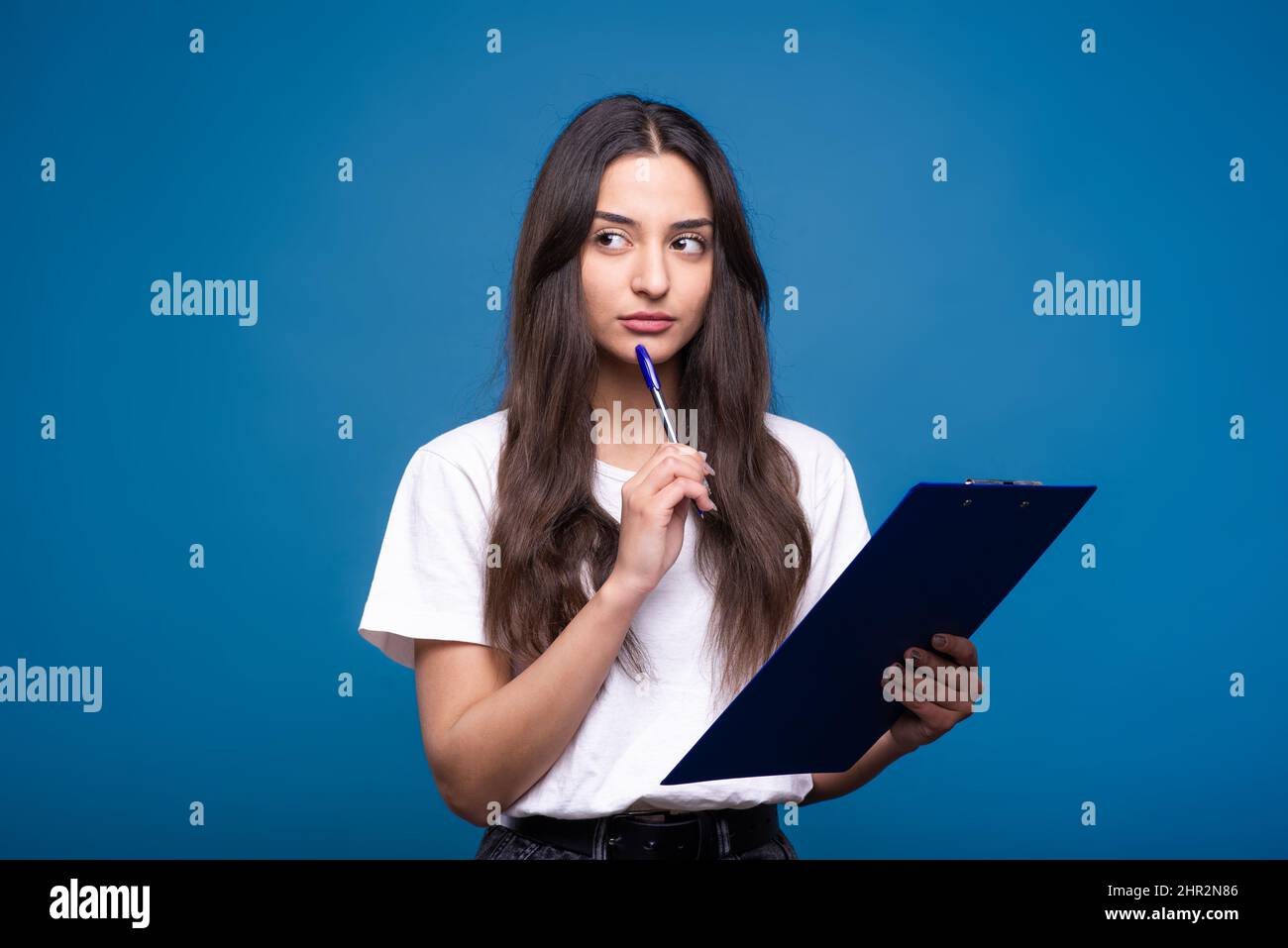 Girl holding pen hi-res stock photography and images - Alamy