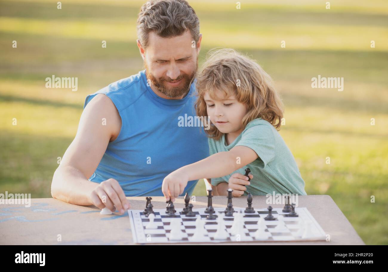 Kid play chess. Father and son playing chess. Fathers Day, love family ...