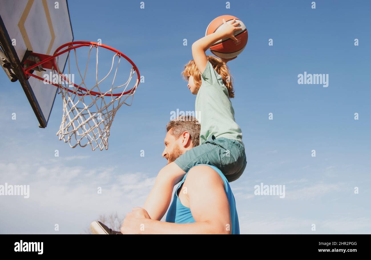 Father and son playing basketball. Dad and child spending time together ...