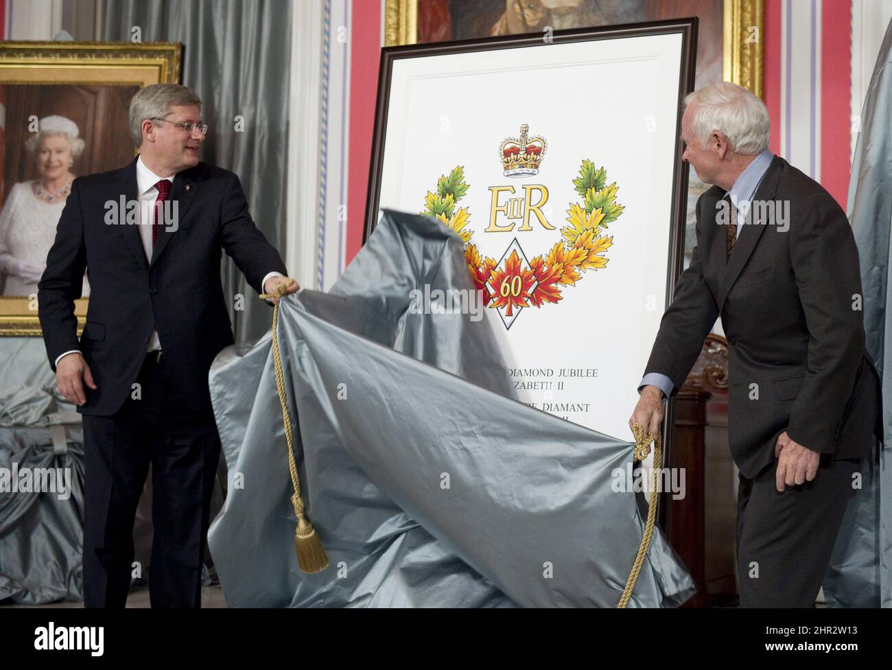 Governor General David Johnston(left) and Prime Minister Stephen Harper unveil the emblem for ...