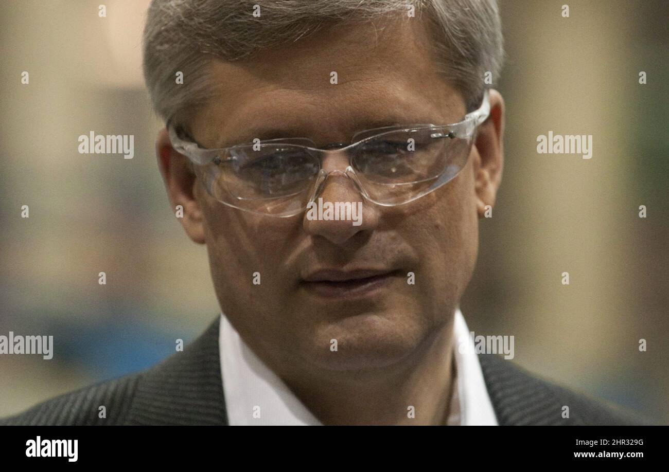 Prime Minister Stephen Harper wears safety glasses over his normal ...