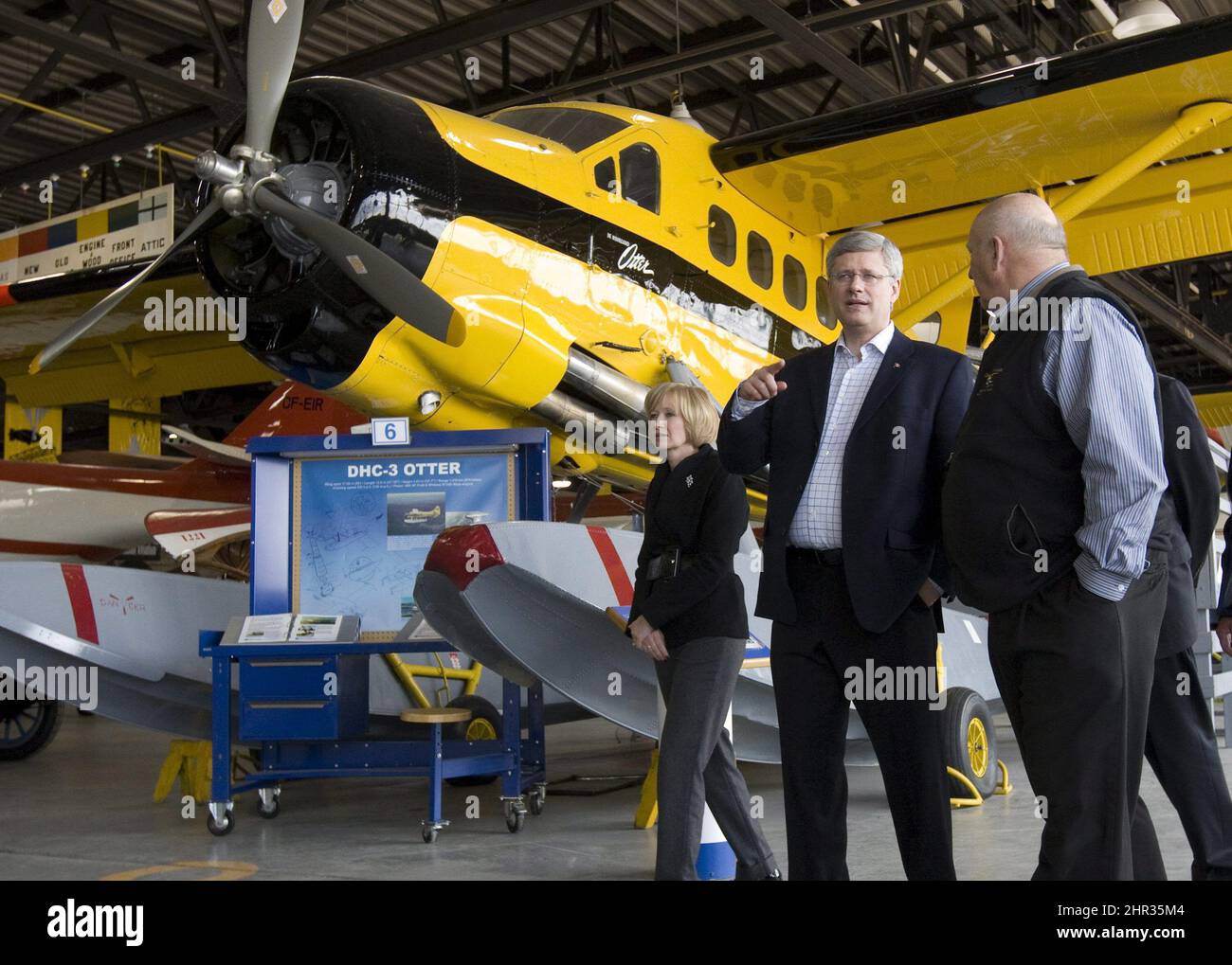 Prime Minister Stephen Harper and Laureen Harper pass a DHC-3 Otter as ...
