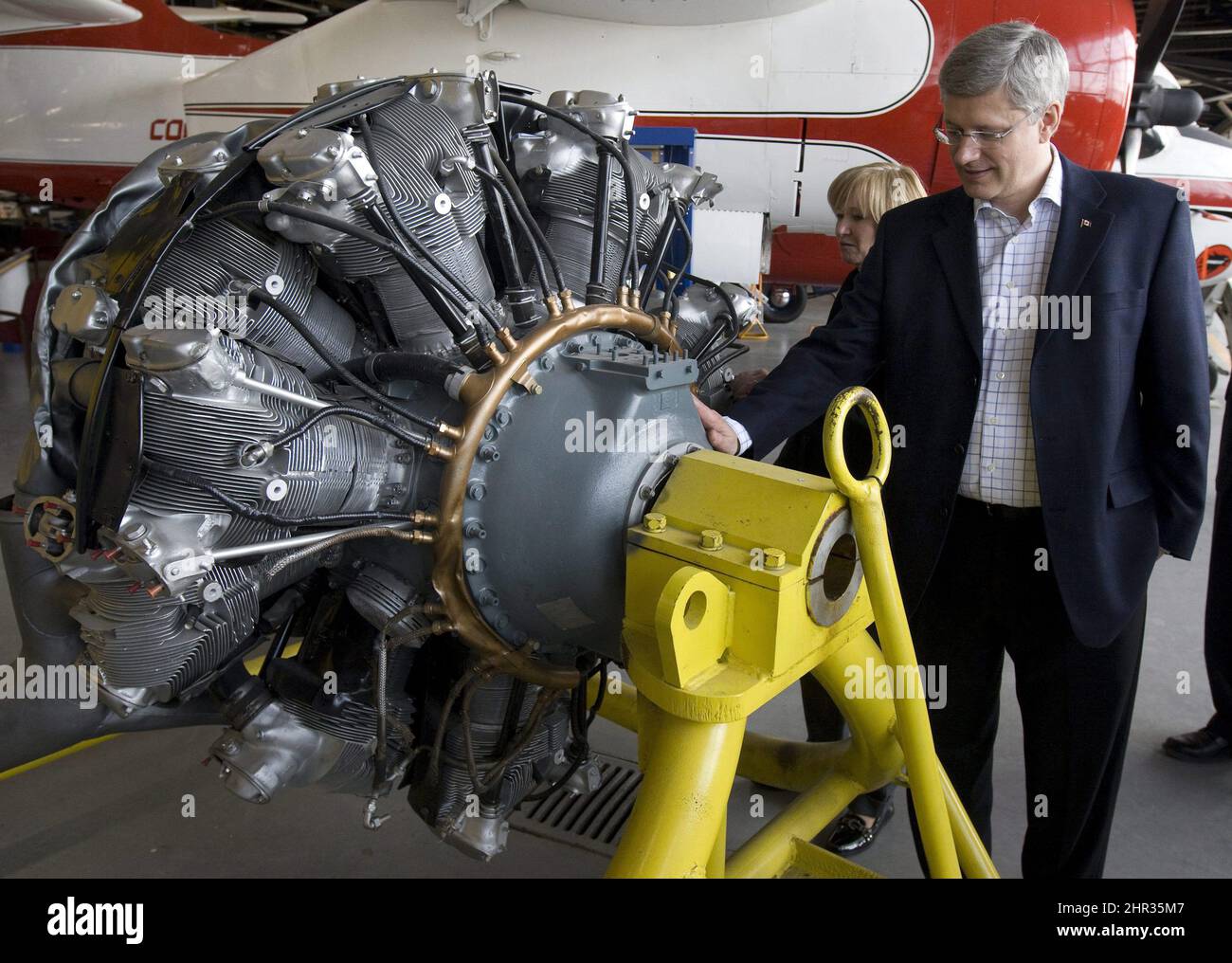 Prime Minister Stephen Harper and Laureen Harper examine a plane engine ...