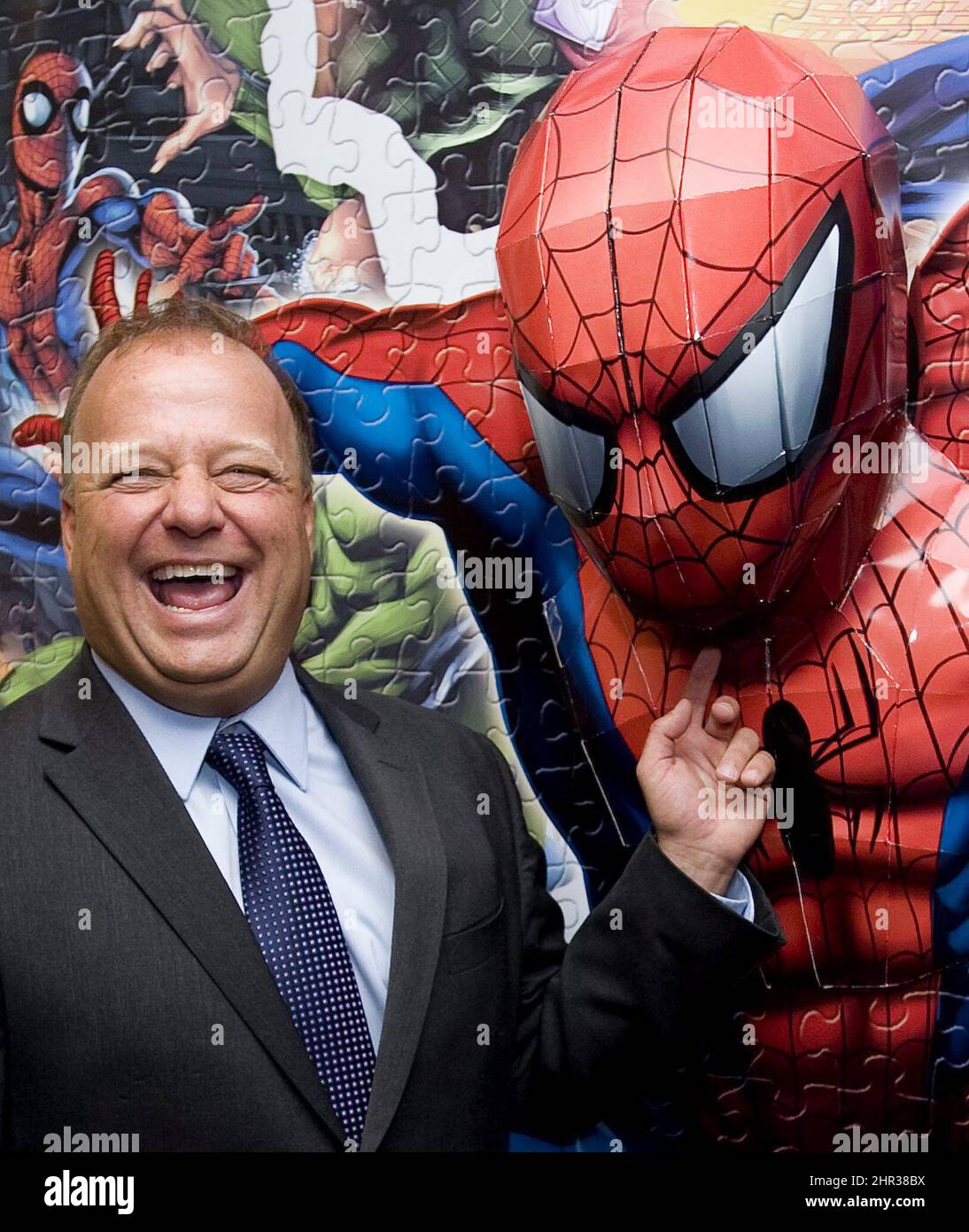 Megabrands CEO Marc Bertrand poses at the company's annual general meeting next to a poster ...
