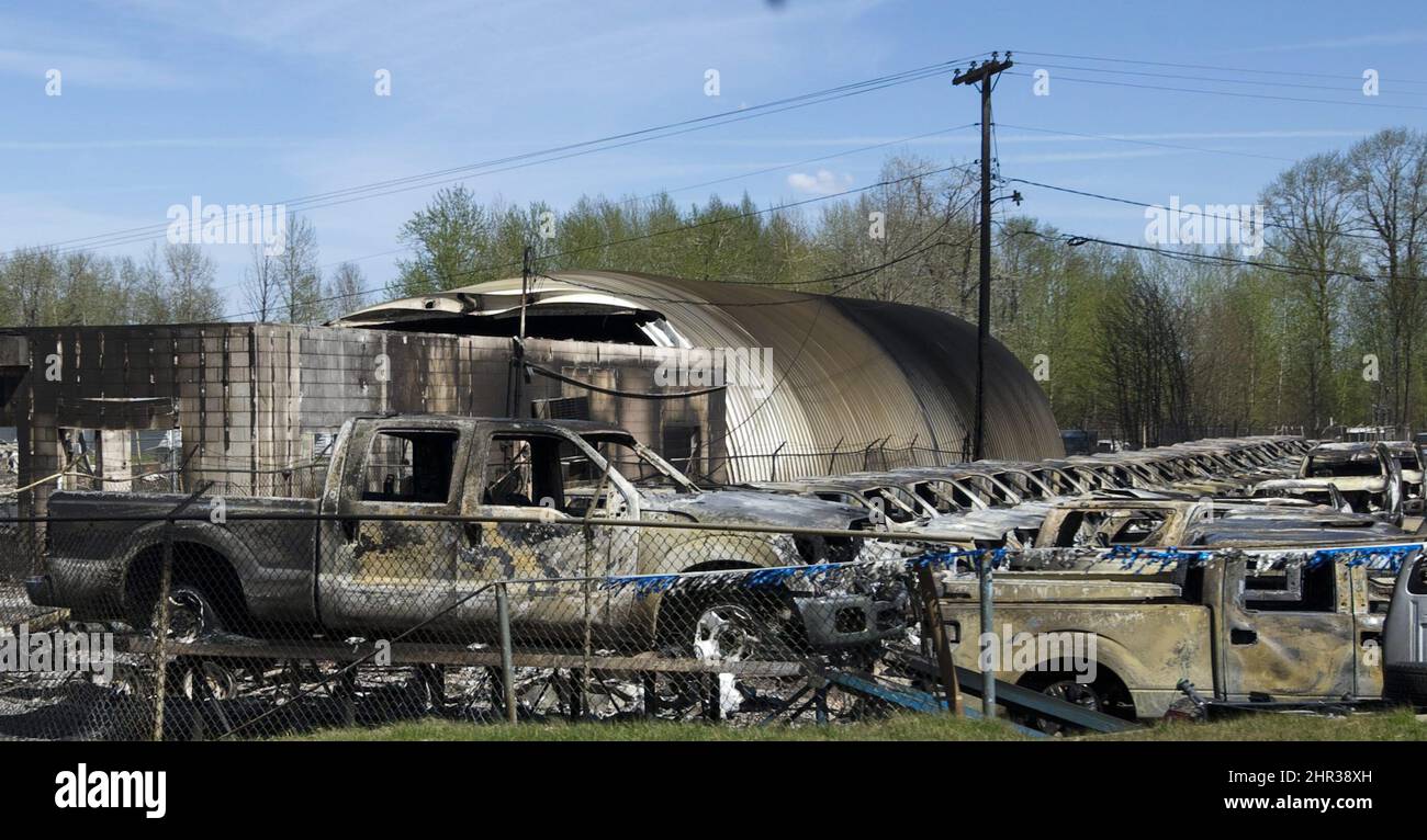 The remains of cars at a dealership in Slave Lake, Alta., on Tuesday ...