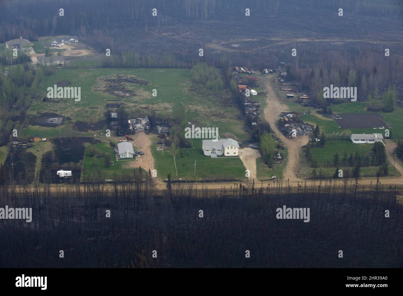 Fire damage is seen from the air as Prime Minister Stephen Harper takes ...