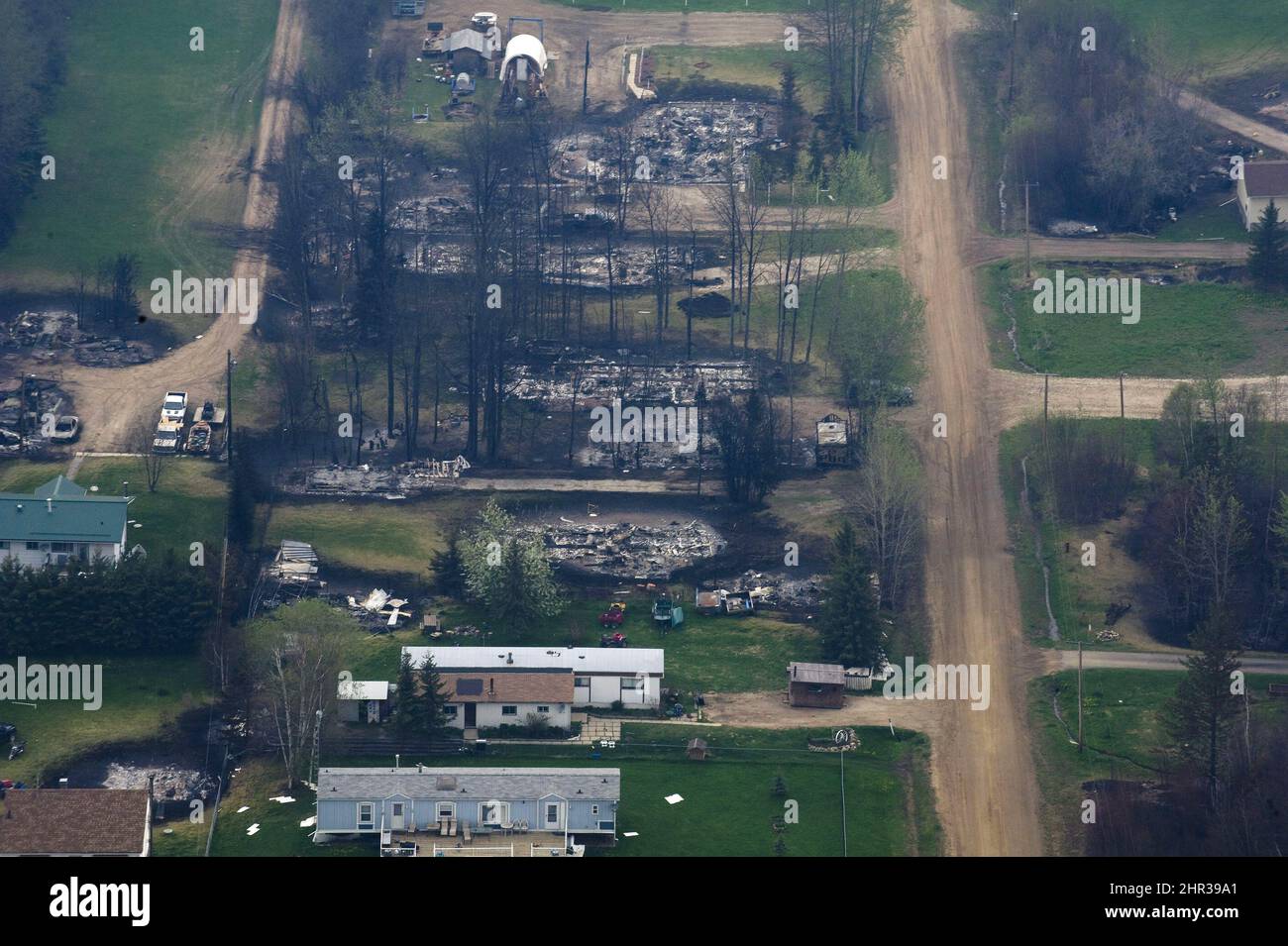 Fire damage is seen from the air as Prime Minister Stephen Harper takes ...