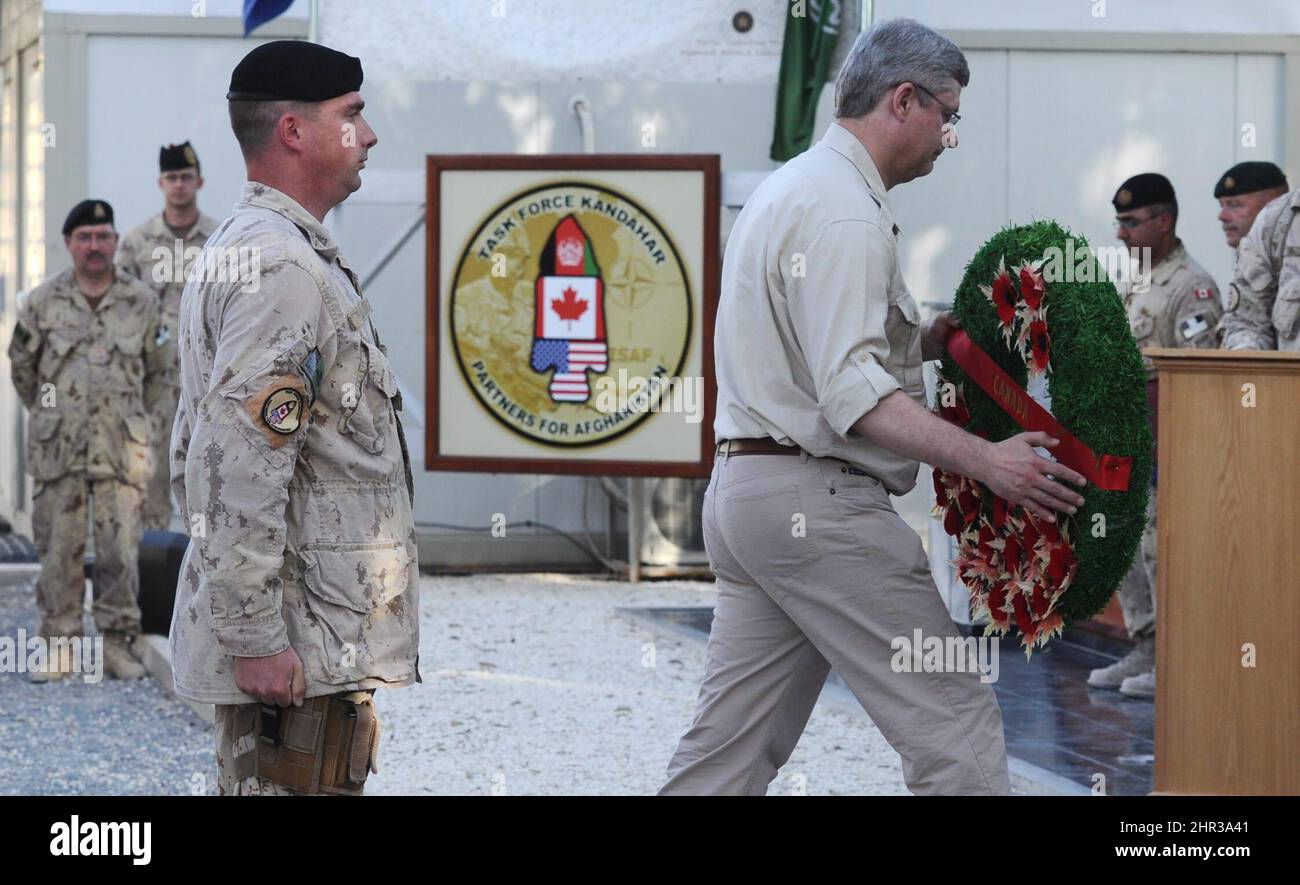 Prime Minister Stephen Harper lays a wreath during a ceremony at ...