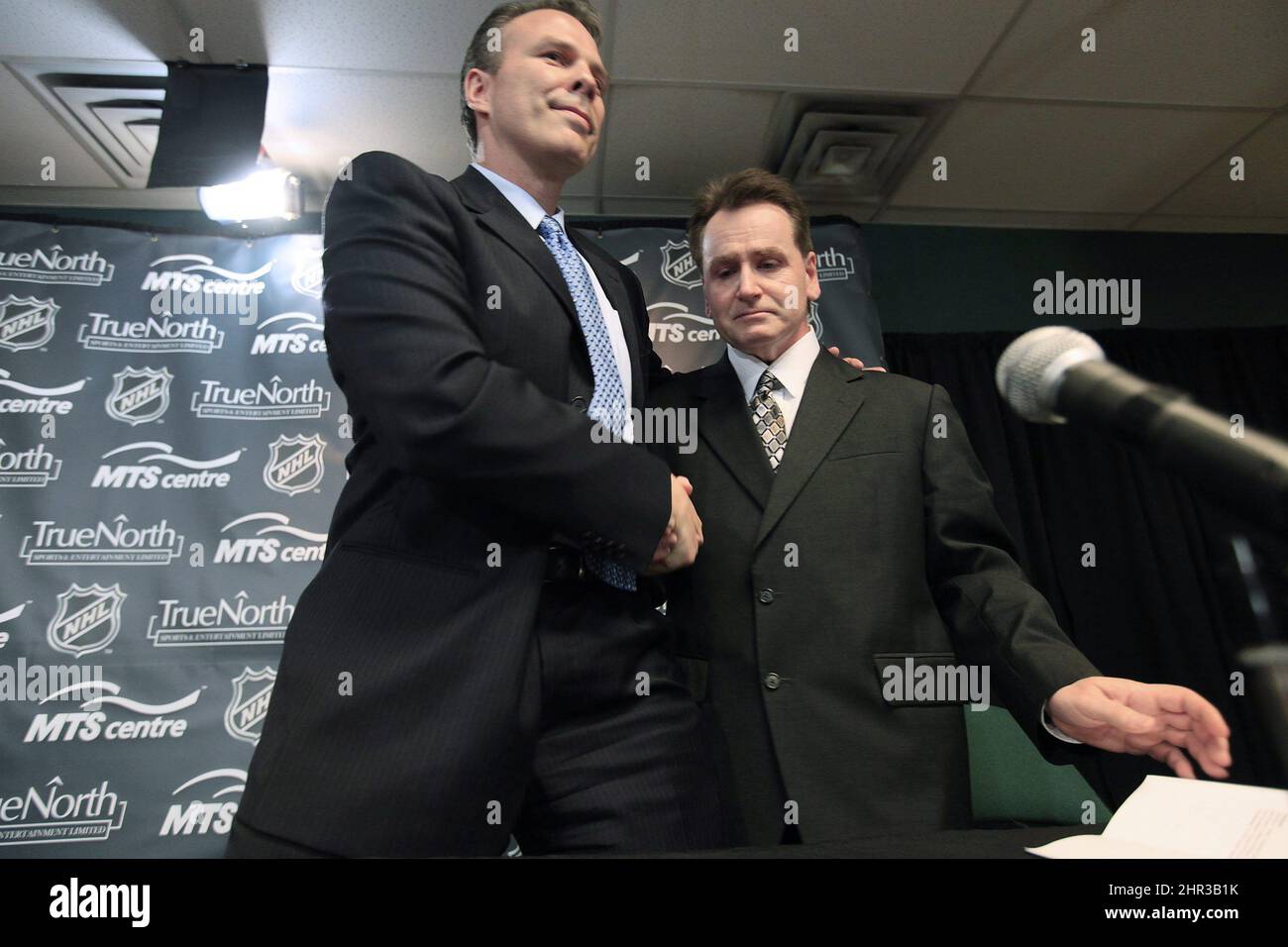 Kevin Cheveldayoff (left) embraces team senior vice-president and ...