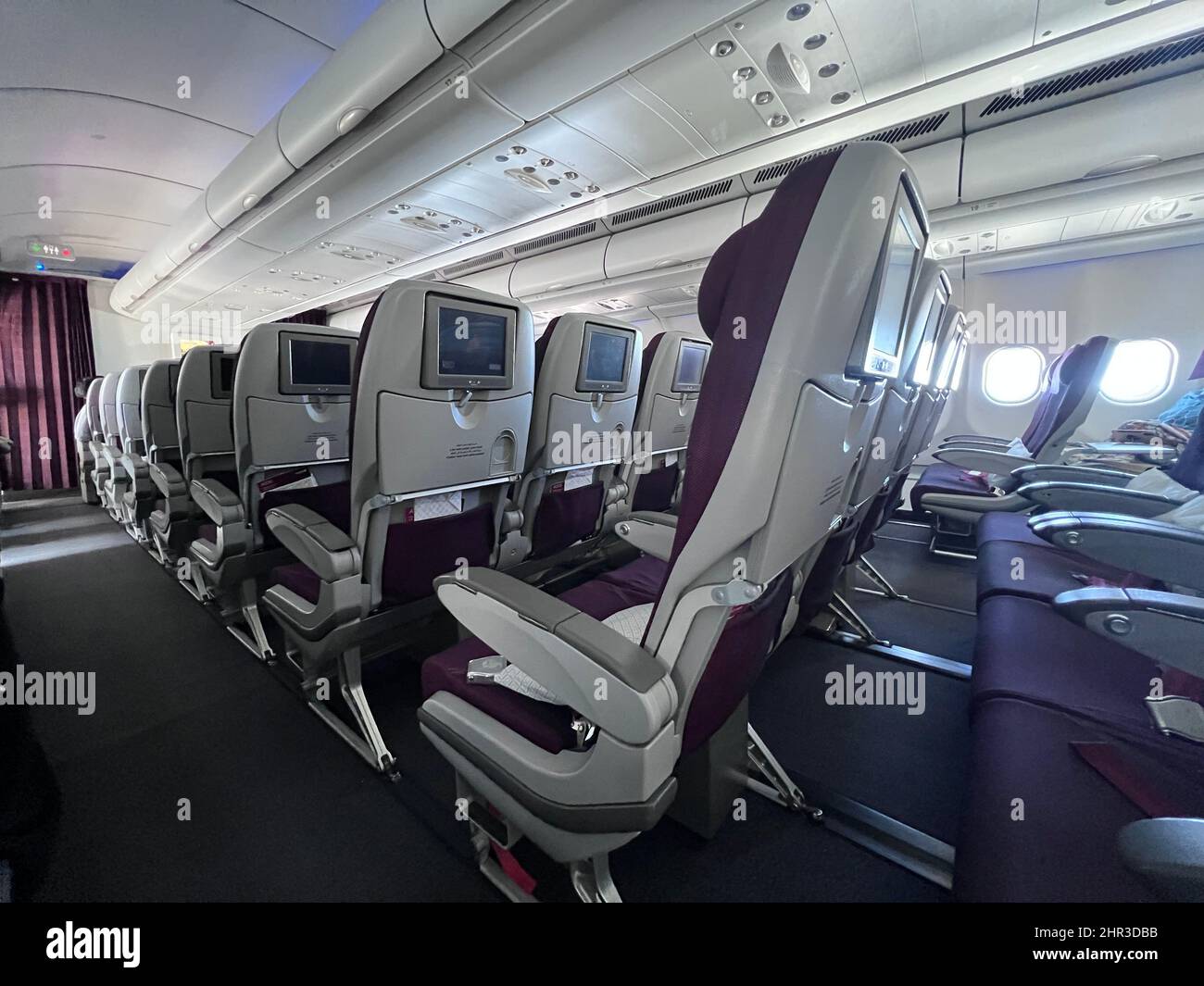 Rows of open seats on Qatar Air flight Stock Photo - Alamy