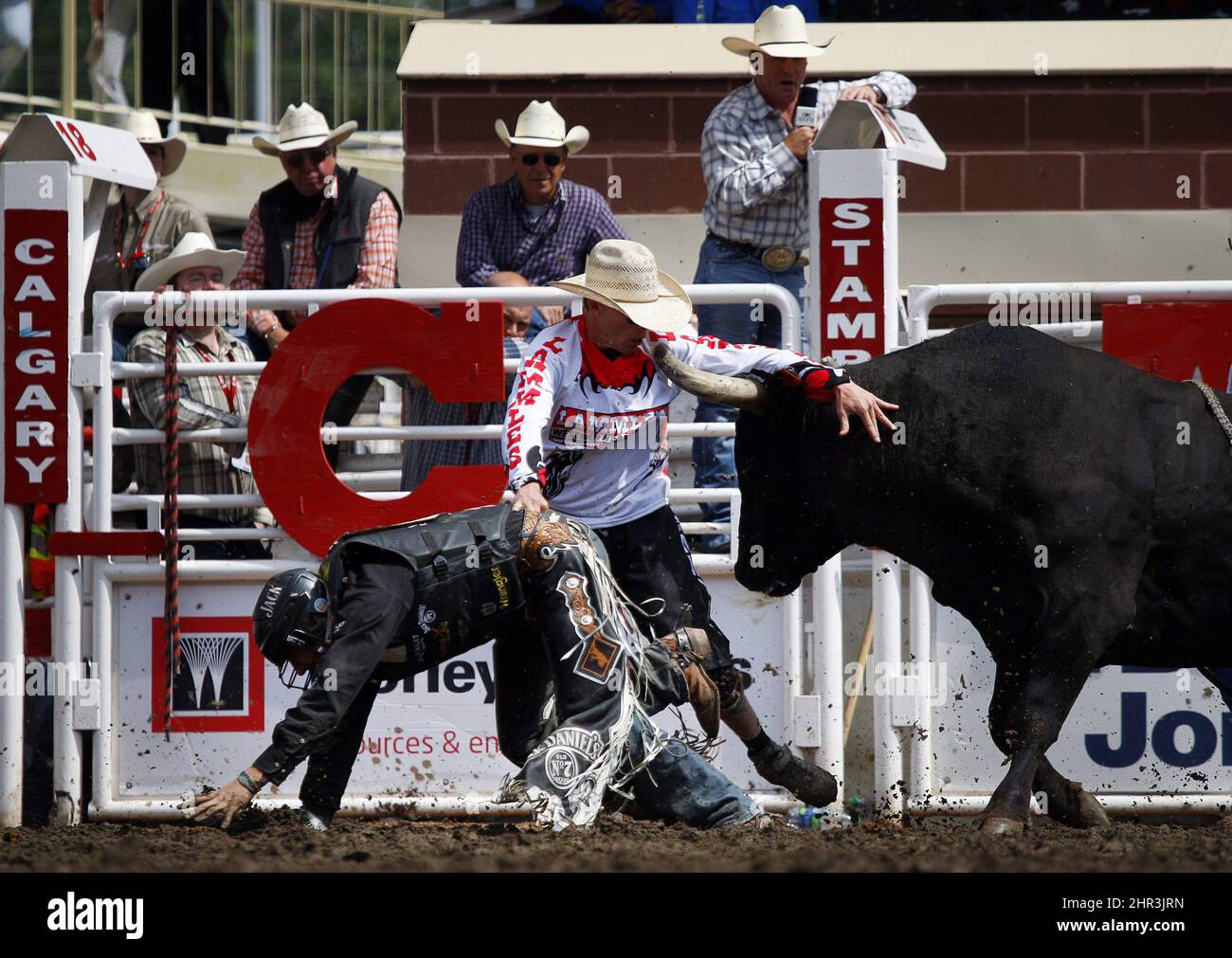 Bullfighter Jesse Byrne, centre, comes to the rescue of Aaron Roy, from ...