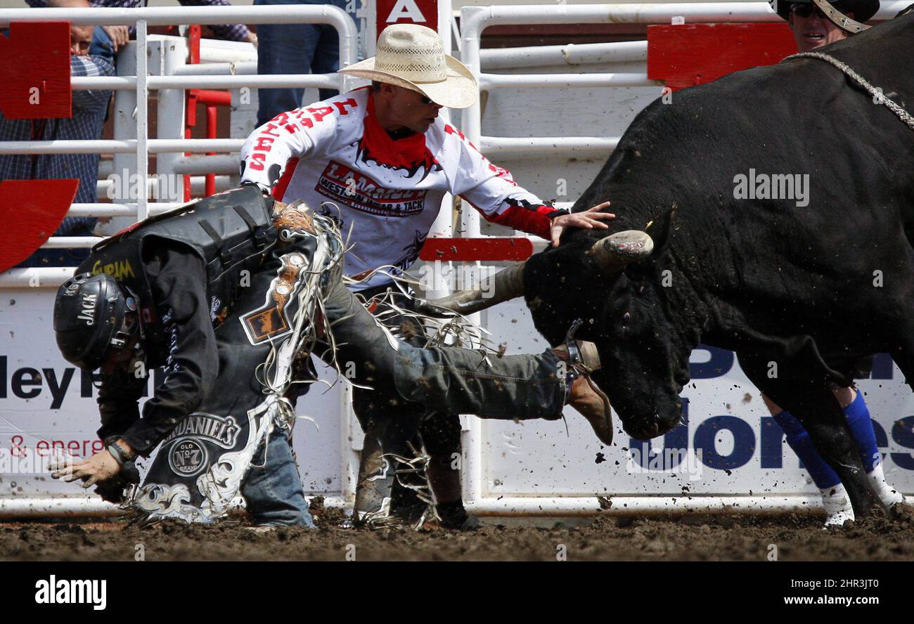 Bullfighter Jesse Byrne, centre, comes to the rescue of Aaron Roy, from ...