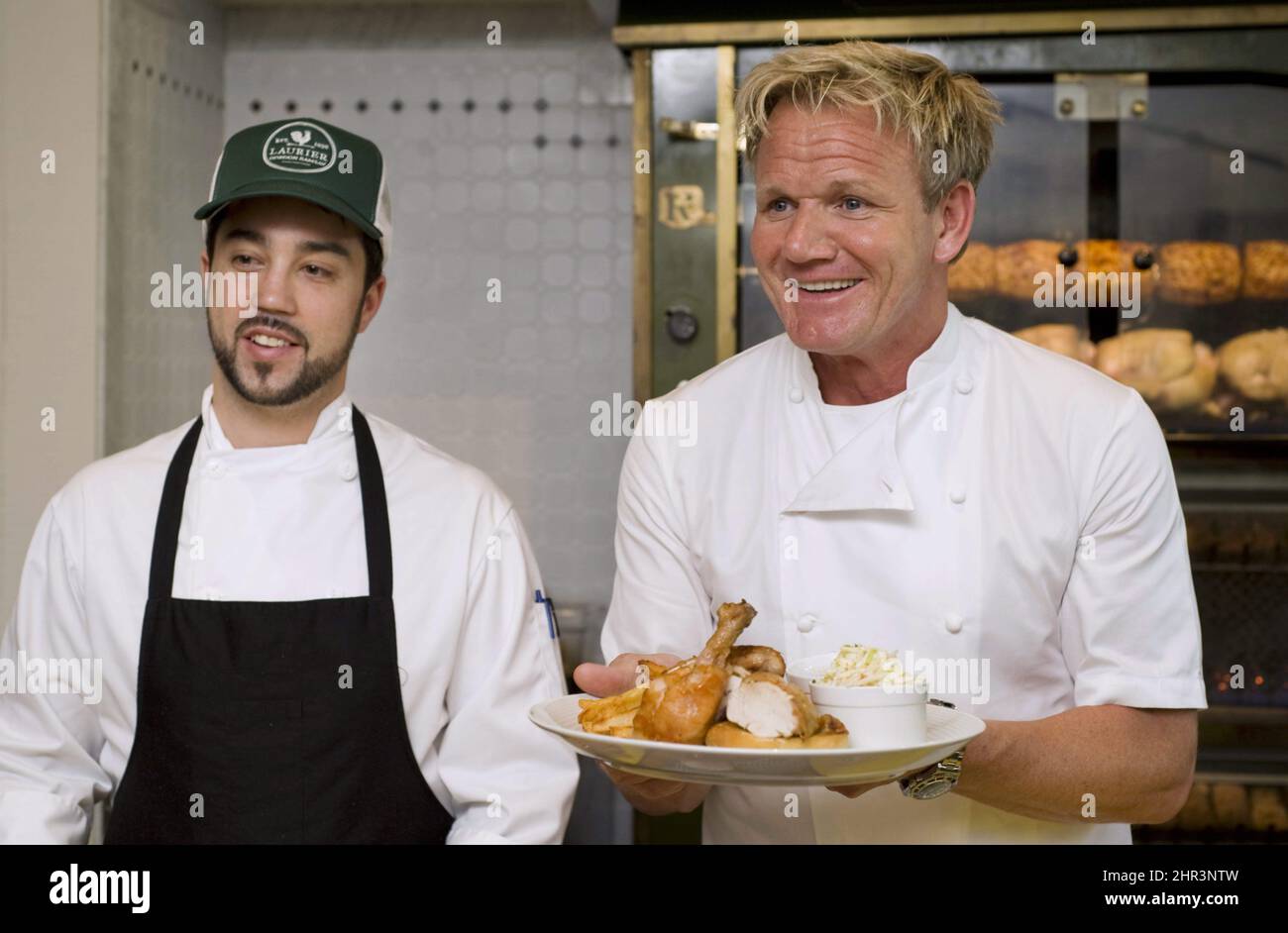 Chef Gordon Ramsay, right, passes out some food during a cooking ...