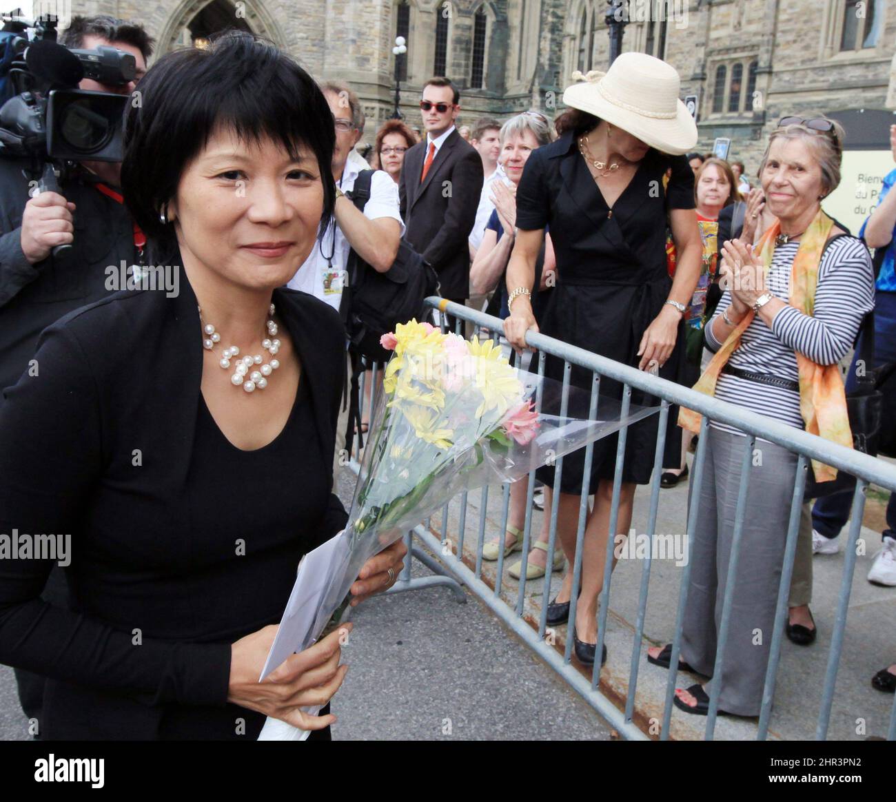 Olivia Chow, wife of NDP Leader Jack Layton, holds flowers she received as she acknowledges ...