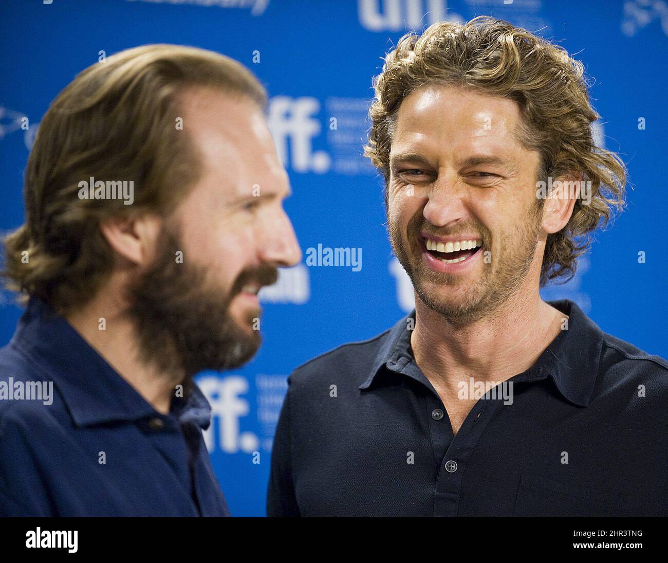 Actor-director Ralph Fiennes, left and Gerard Butler share a laugh at a ...