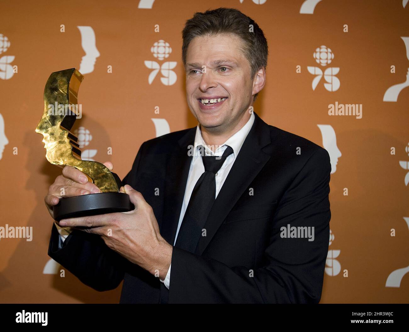 Real Bosse holds up his trophy for best actor in a dramatic role at the ...