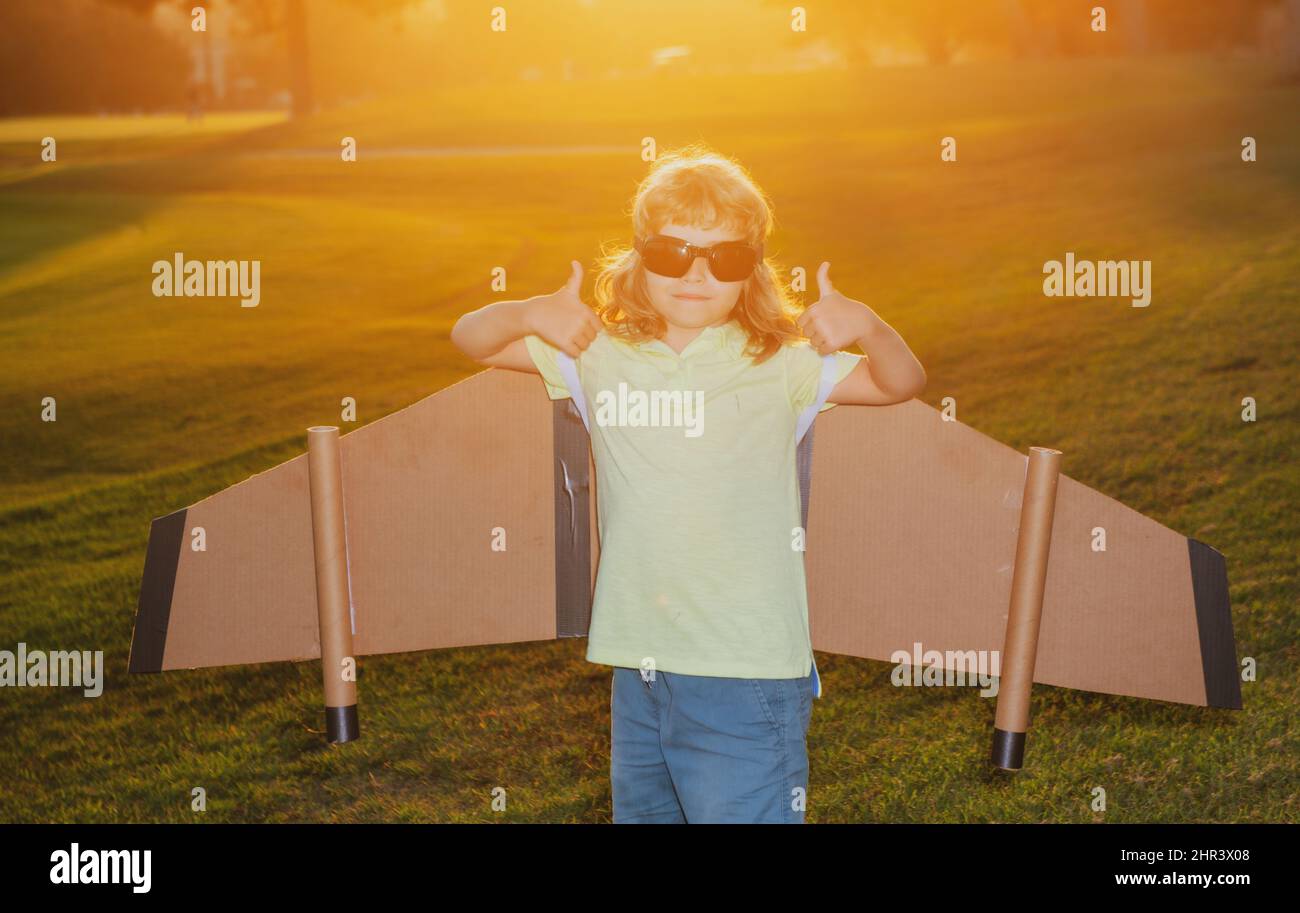 Child with pilot glasses playing with toy jetpack. Child pilot ...