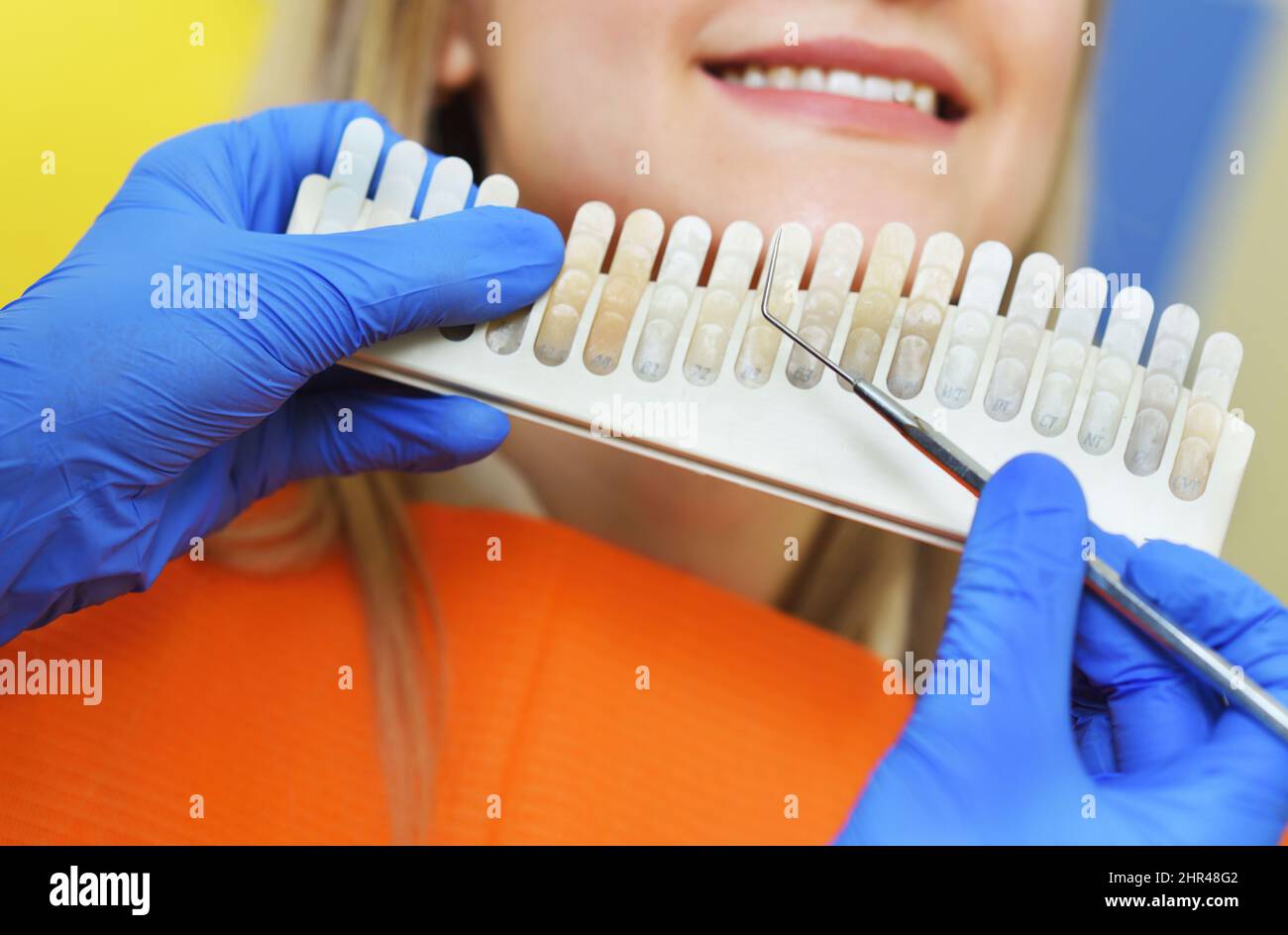 the dentist selects the right shade of teeth on special equipment Stock ...
