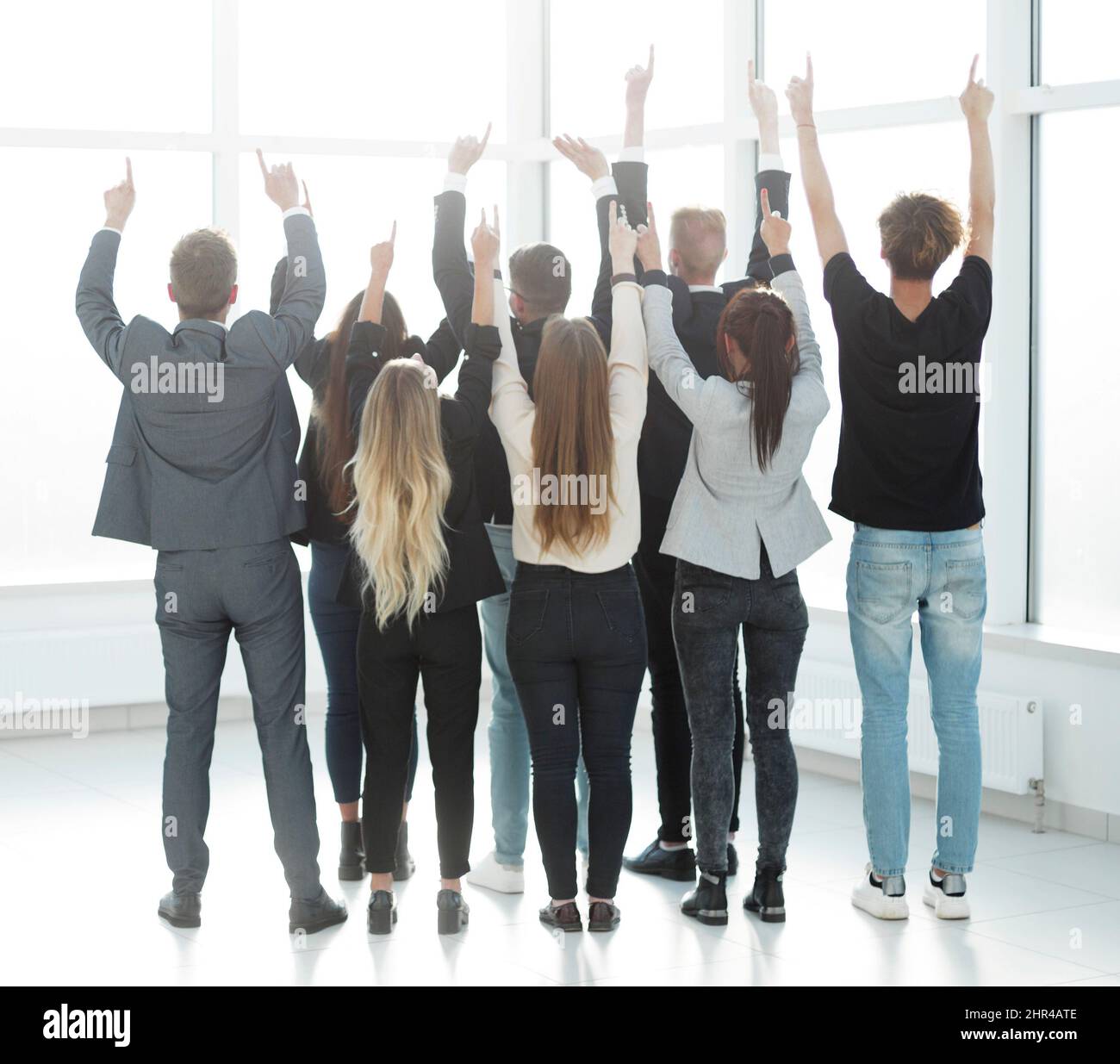 rear view. groups of young business people pointing up Stock Photo - Alamy