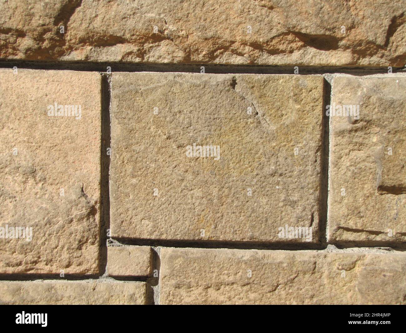 Background natural stone wall rectangular geometric illuminated by the ...