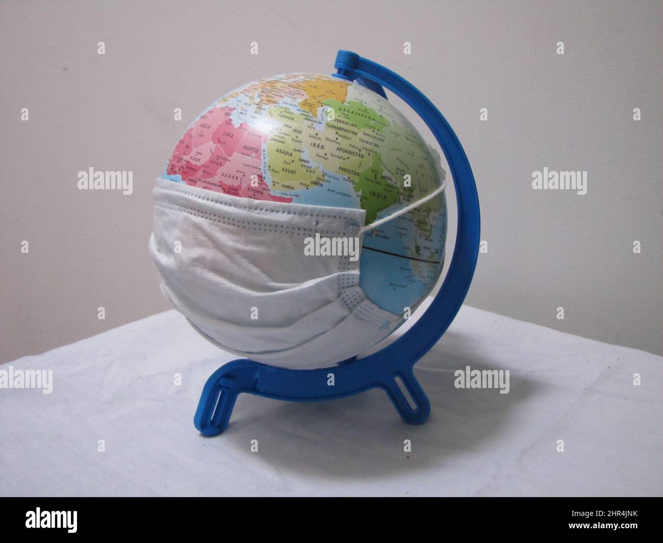 The world with a mask to avoid contracting the coronavirus. Plastic toy ...