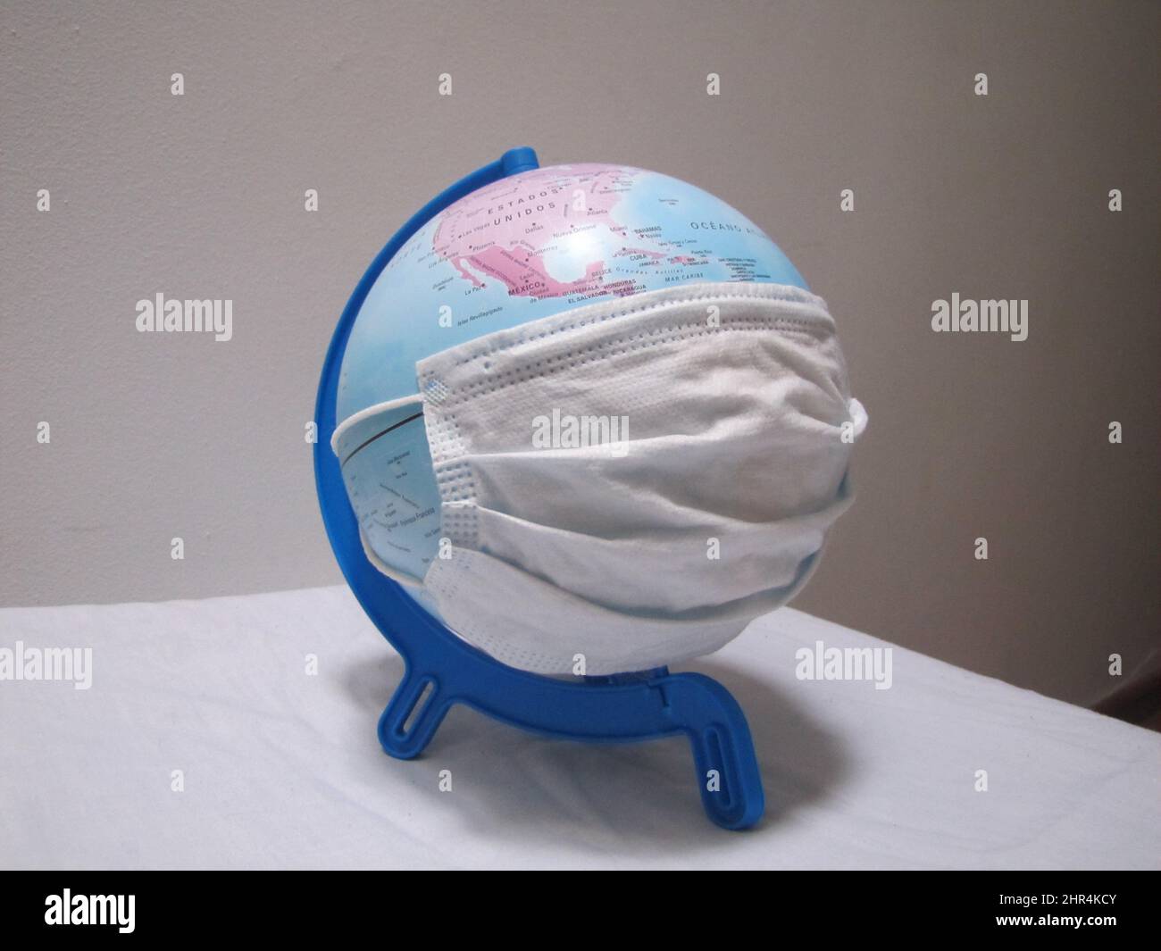 The world with a mask to avoid contracting the coronavirus. Plastic toy ...
